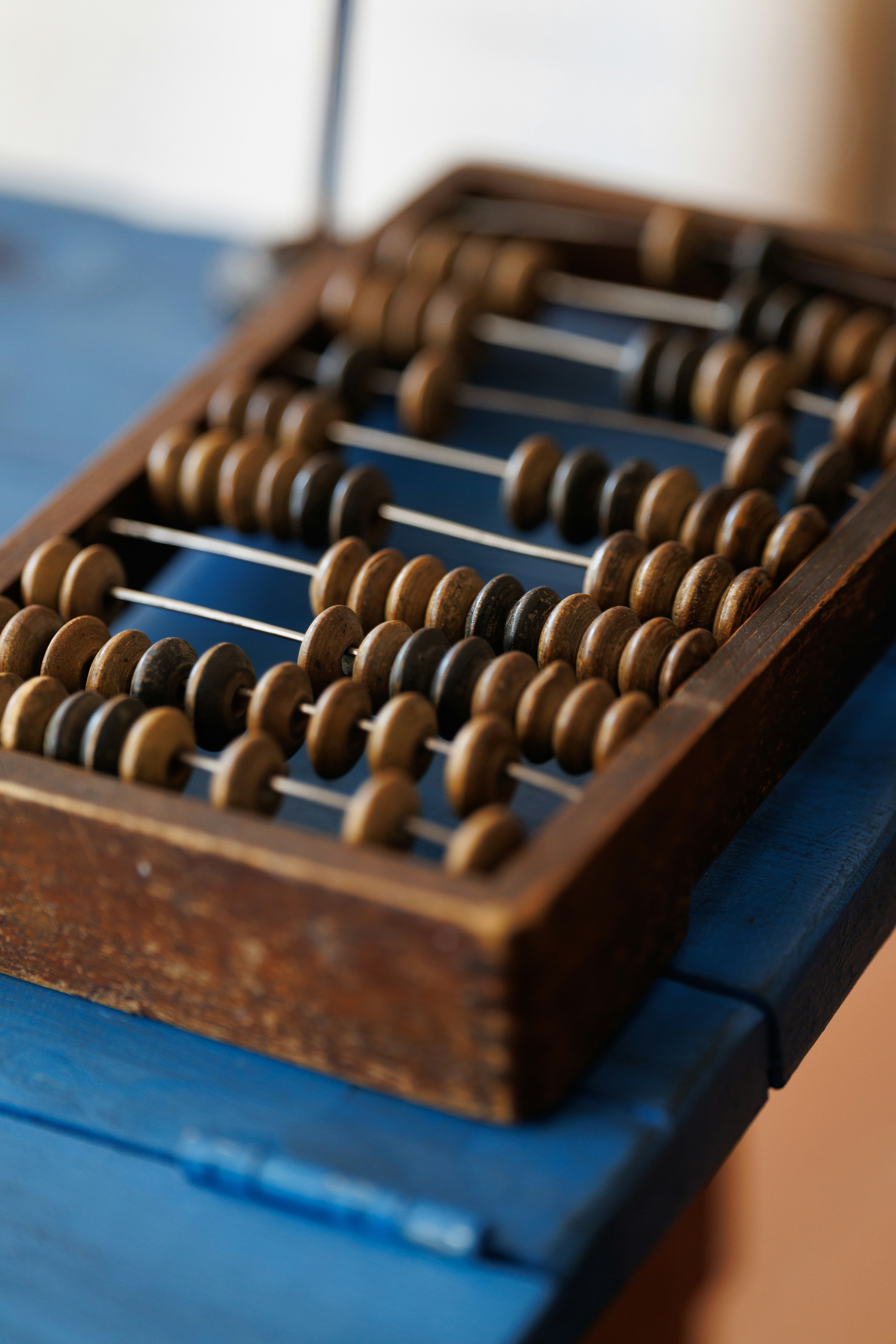 Aged Abacus Resting on Blue Planks