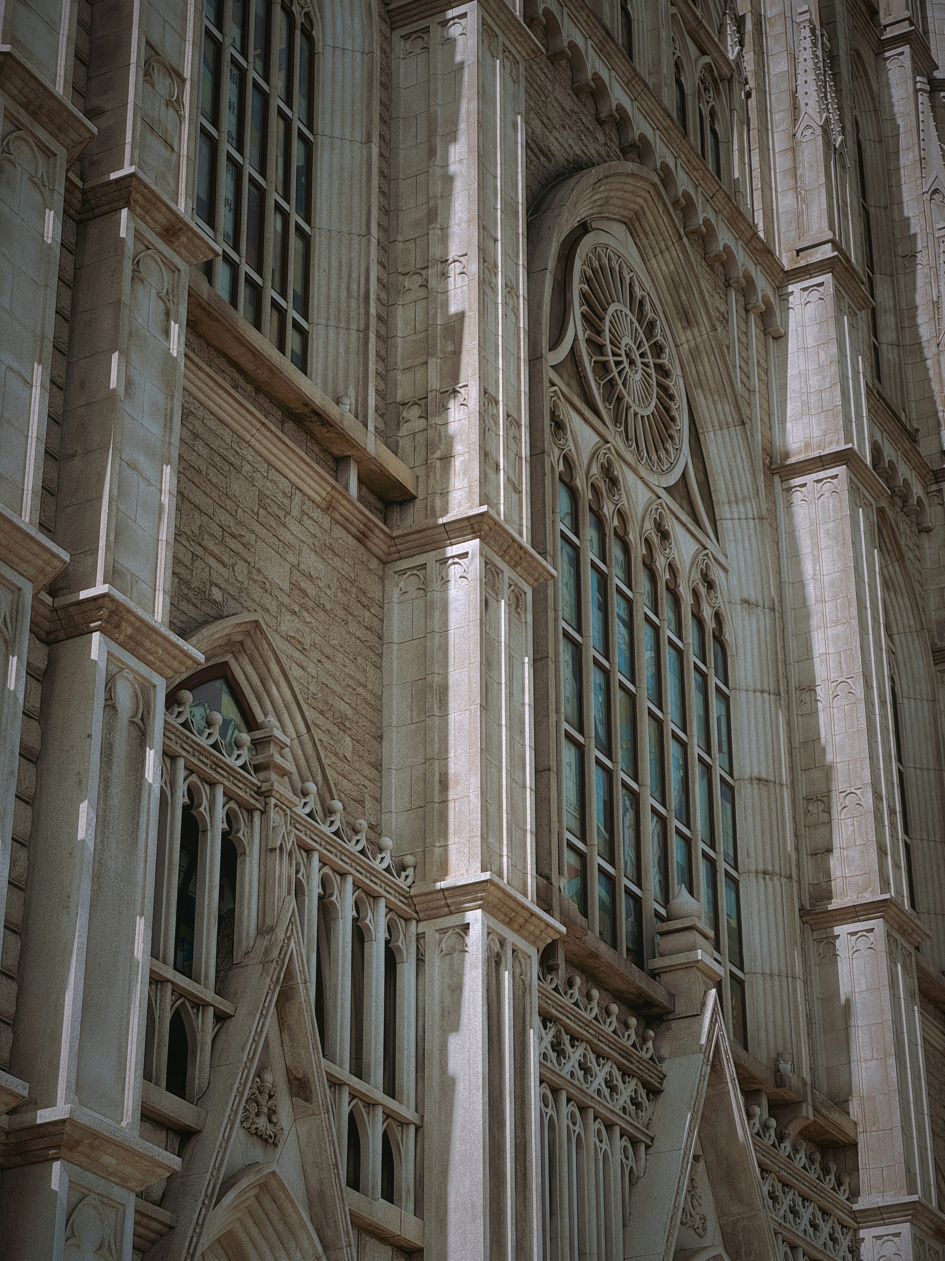 Gothic Facade in Stone Light: A Rain-Washed Cathedral Wall