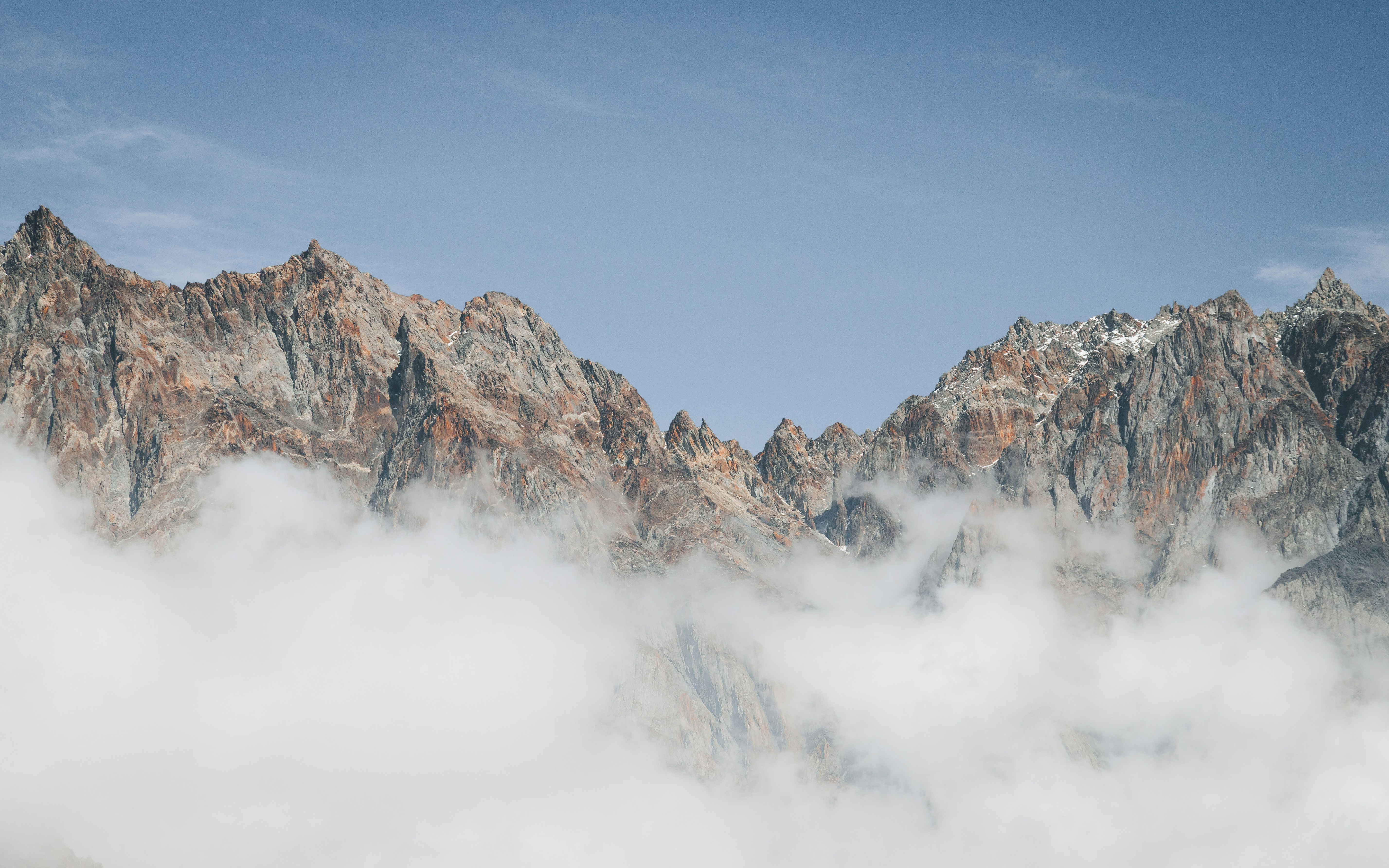 Snow-Capped Ridge Breaking Through a Veil of Clouds