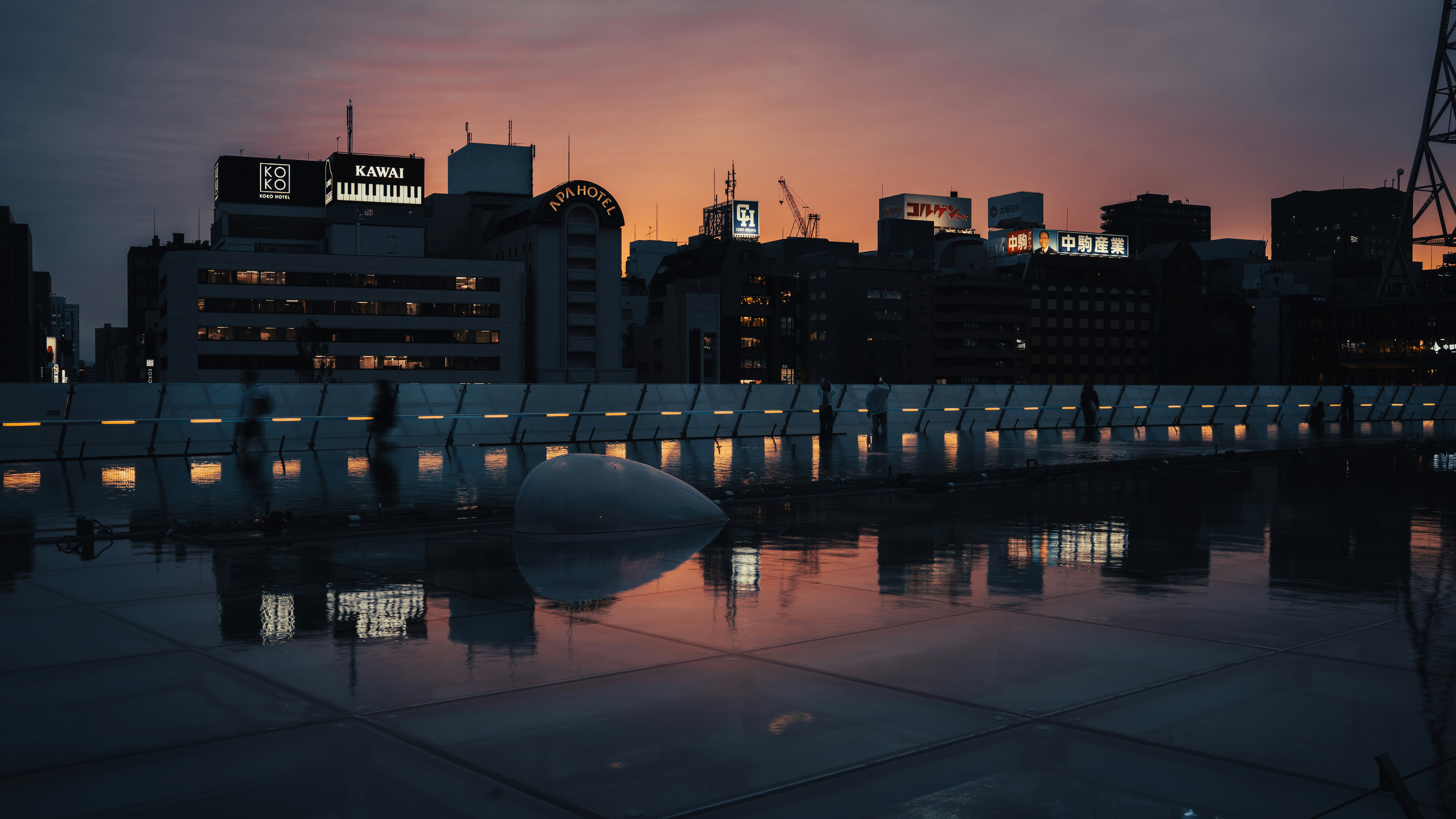 Urban Sunrise: Gentle Ripples Reflect a Distant Skyline