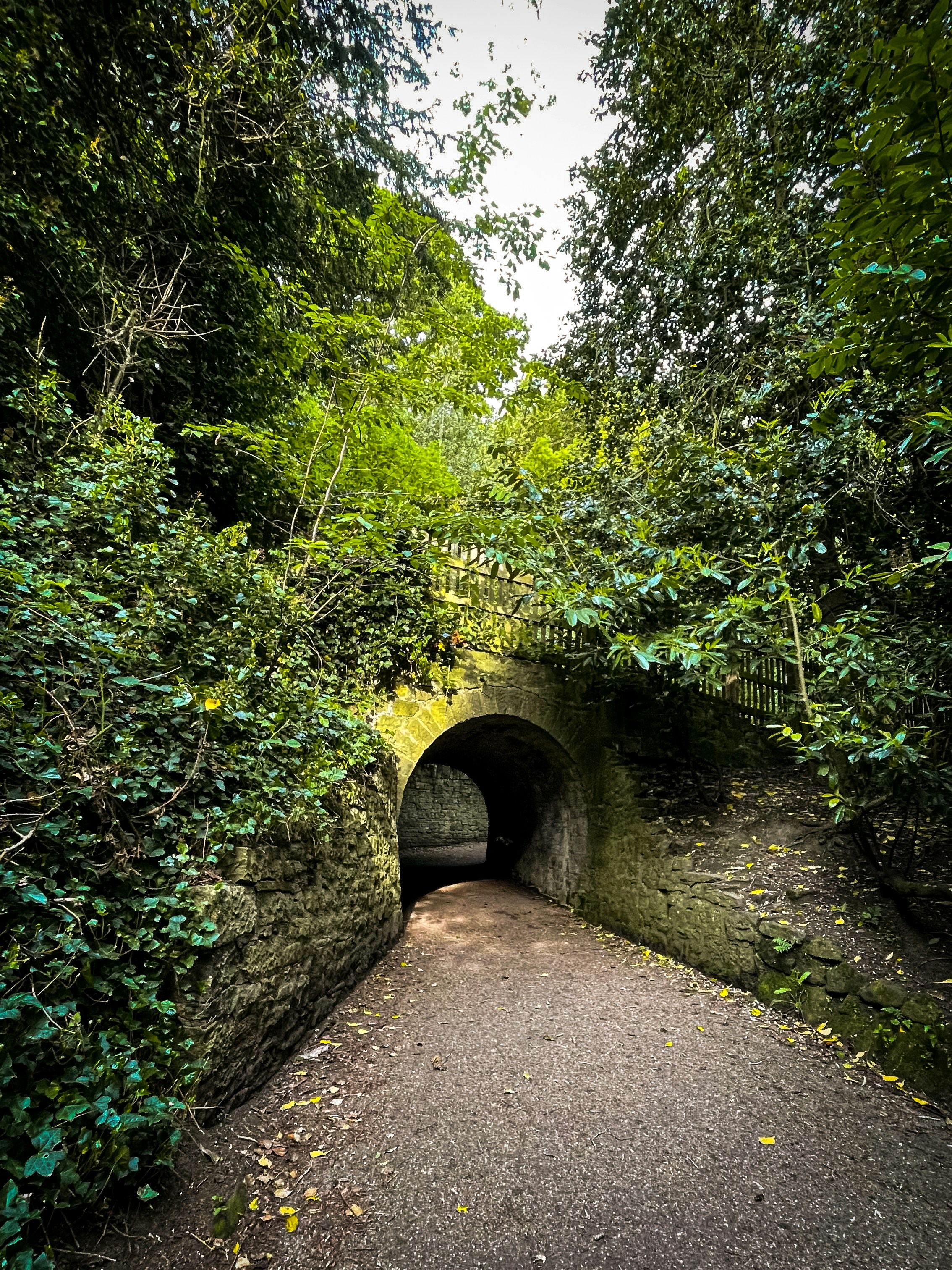 Stone Archway Beneath a Shaded Arched Tunnel