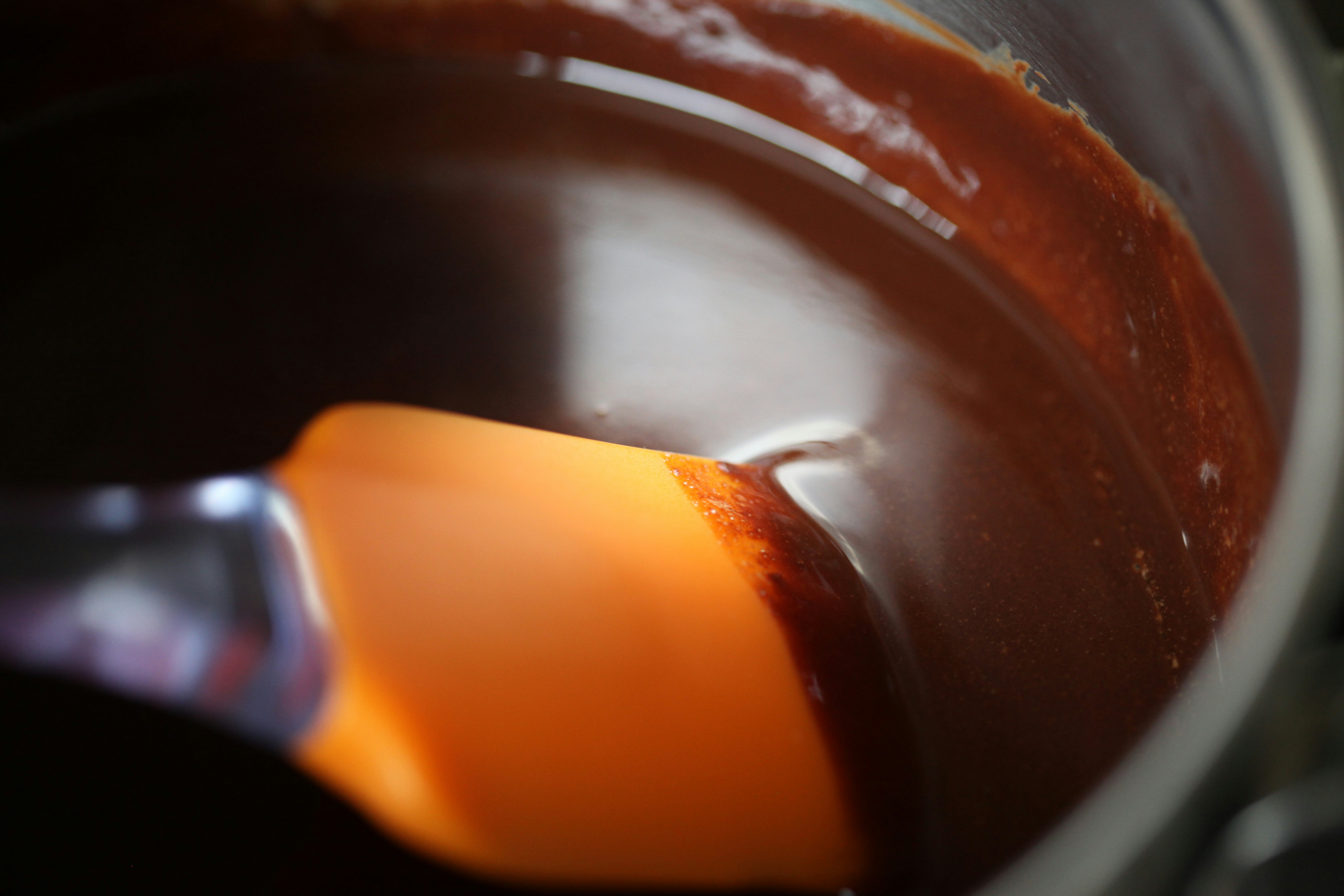 Glossy Chocolate Matrix: A Spatula Dips Into Velvet Brown
