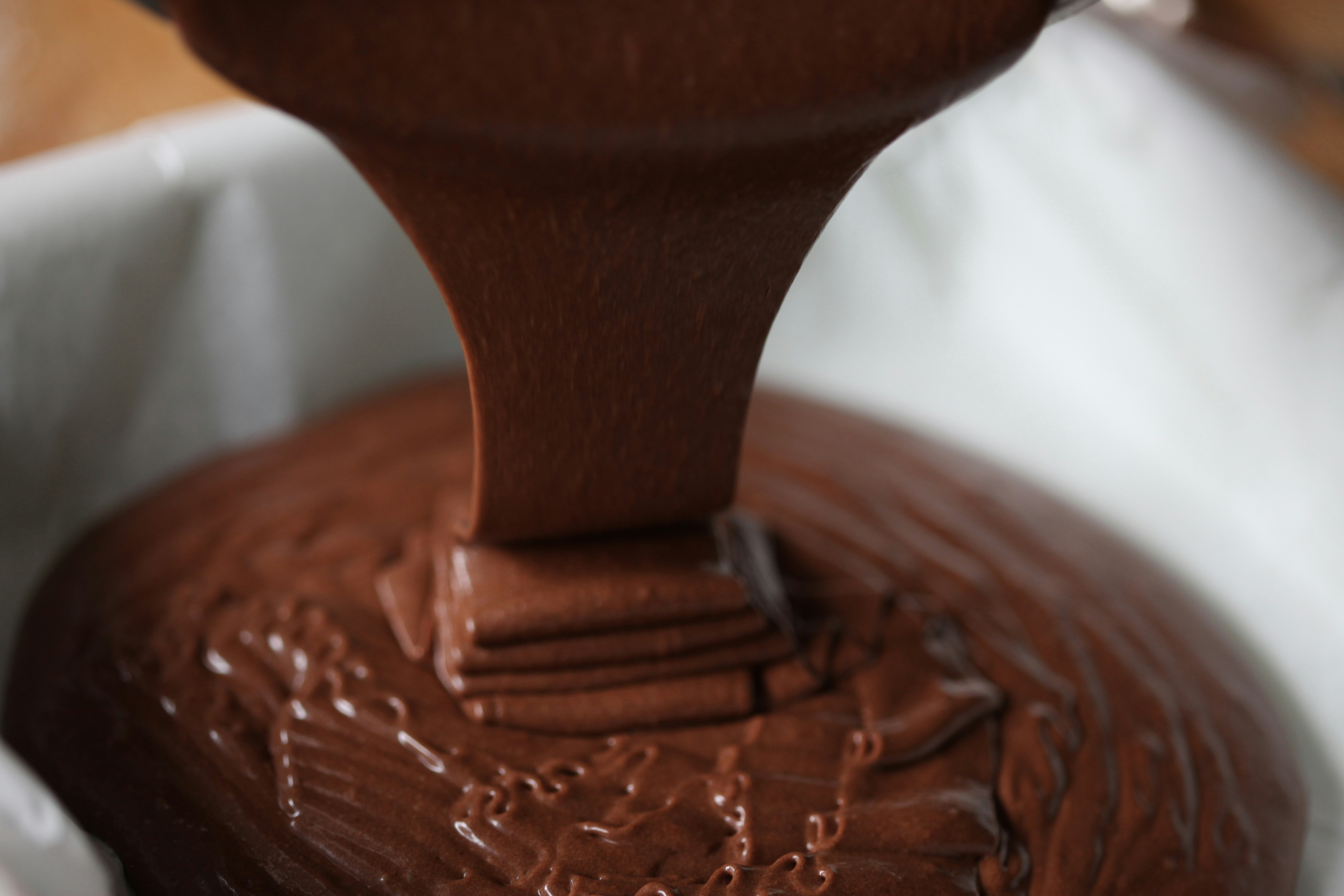 Pouring Cascade: A Close-Up of Chocolate Accents in Syrup-Like Flow