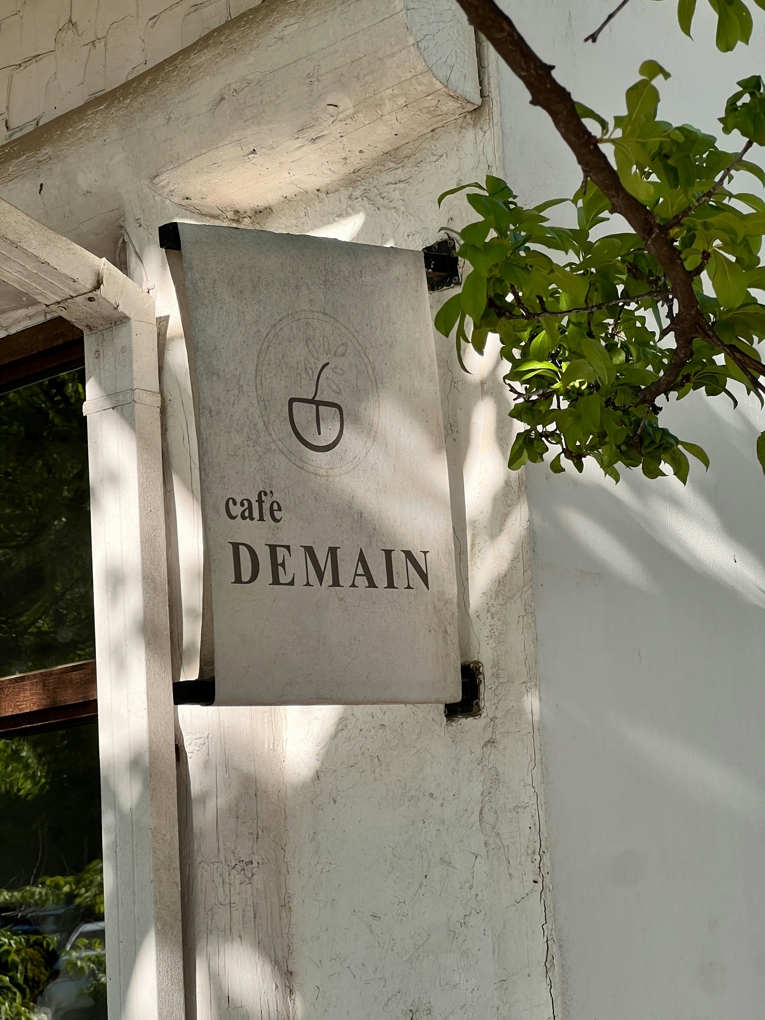 Cafe Demain Sign in Warm Sunlight