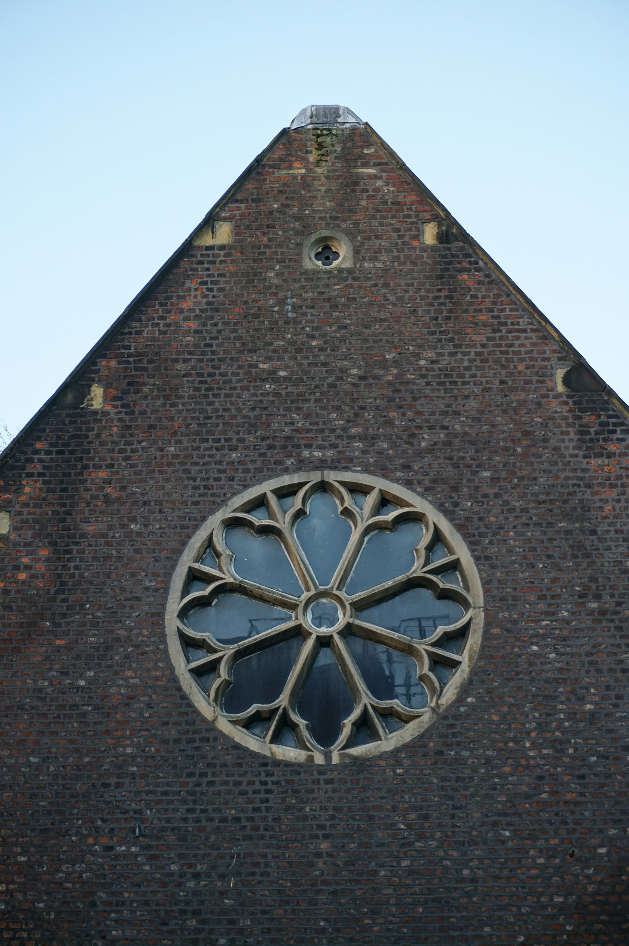 Circles and Brick: A Gothic Rose on a Brick Facade
