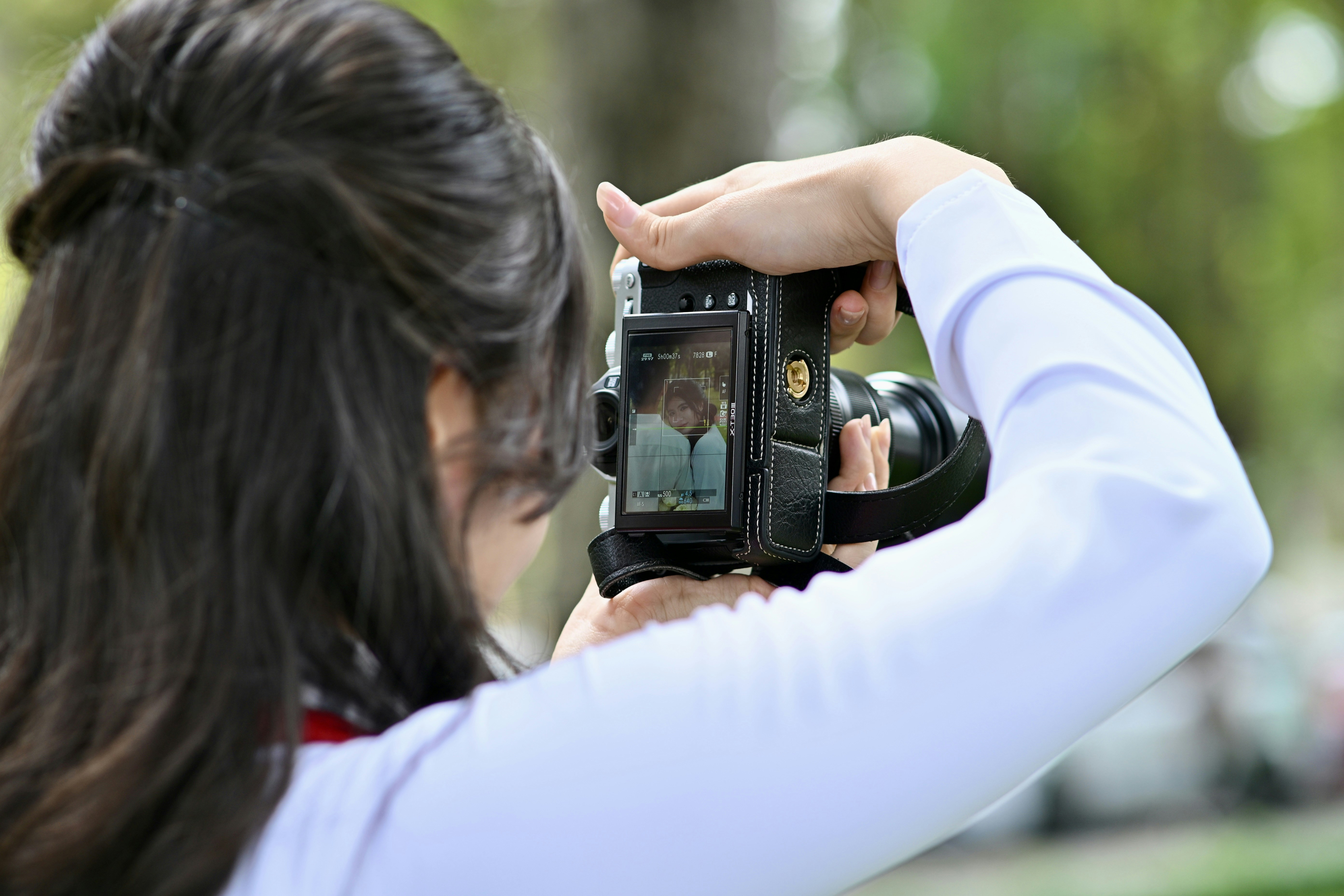 Focused Eye on the Viewfinder: A Photographer in Action