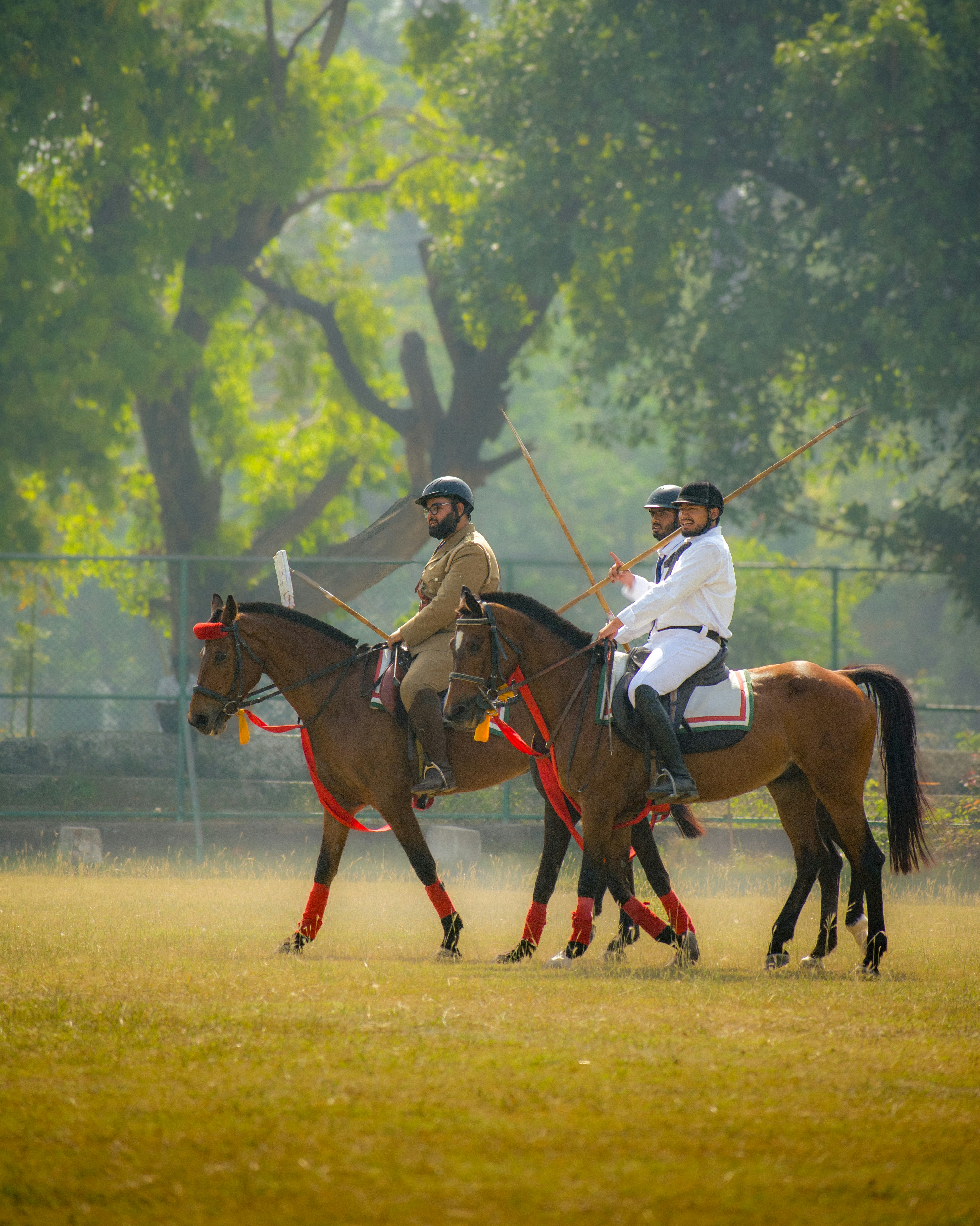 Triumph in the Arena: Riders in Red Accents Parade Across the Field