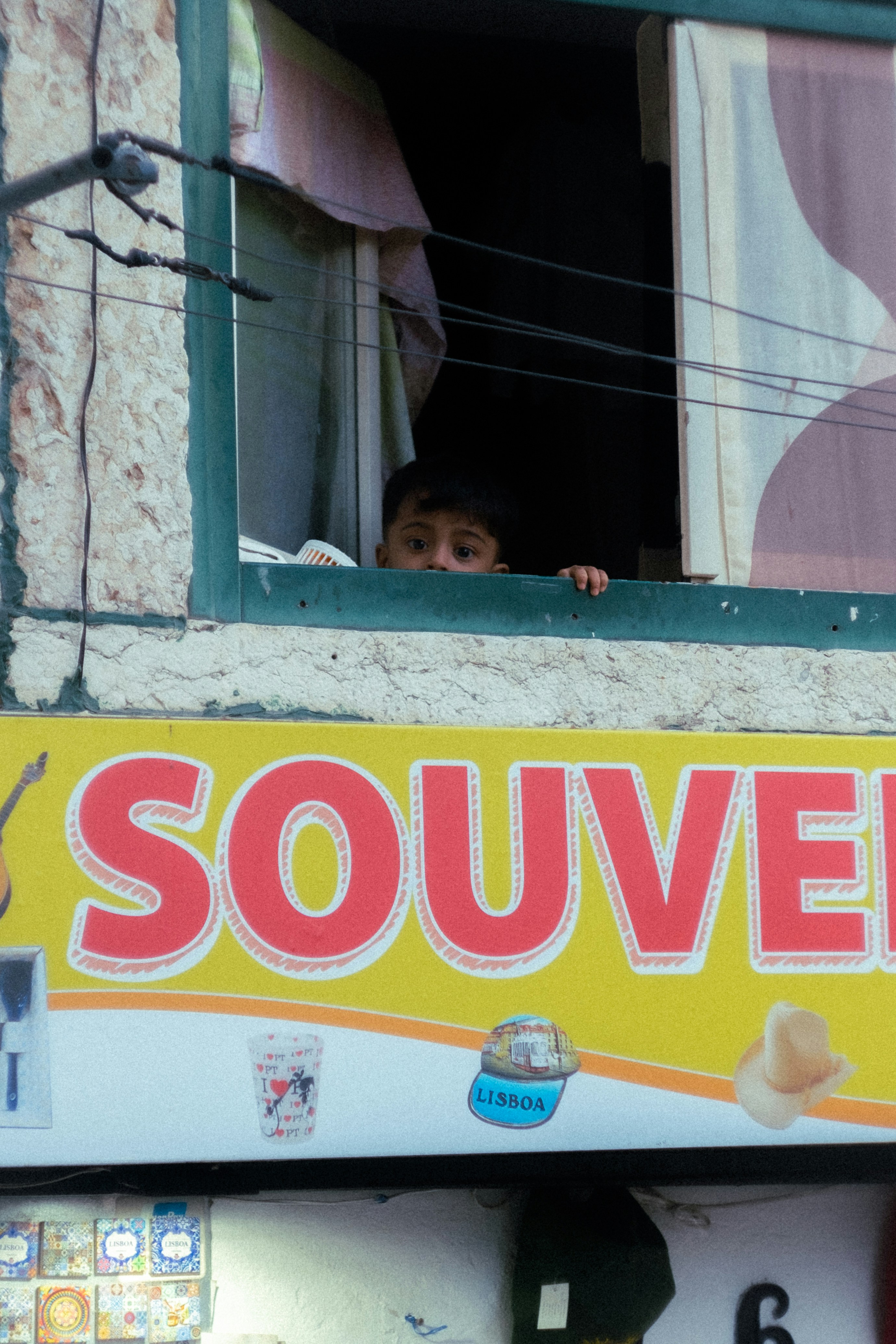 Curious Child Eyes Over the Souvenir Stand