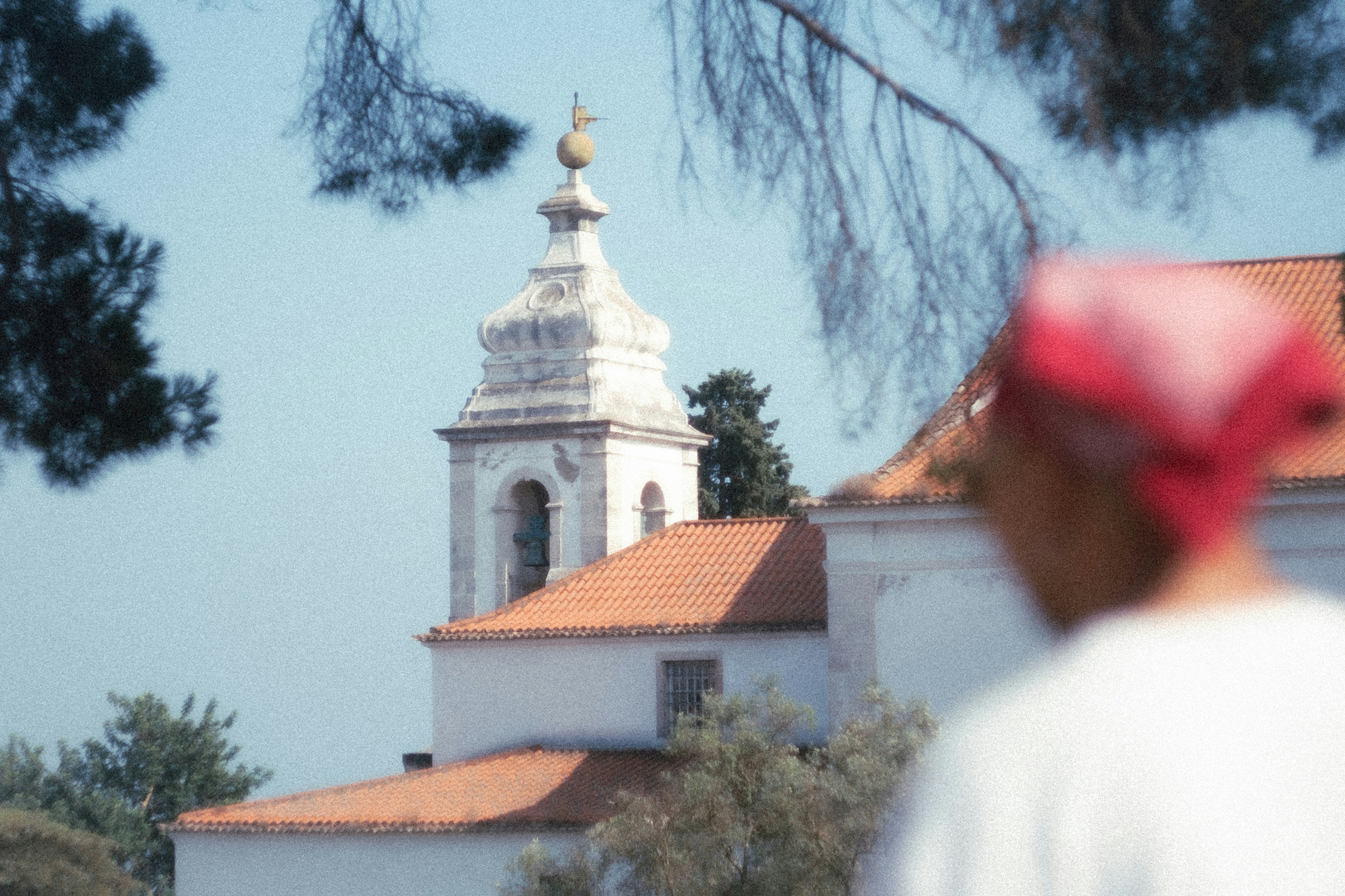 Pastel Bell Tower in a Sunlit Mediterranean Courtyard
