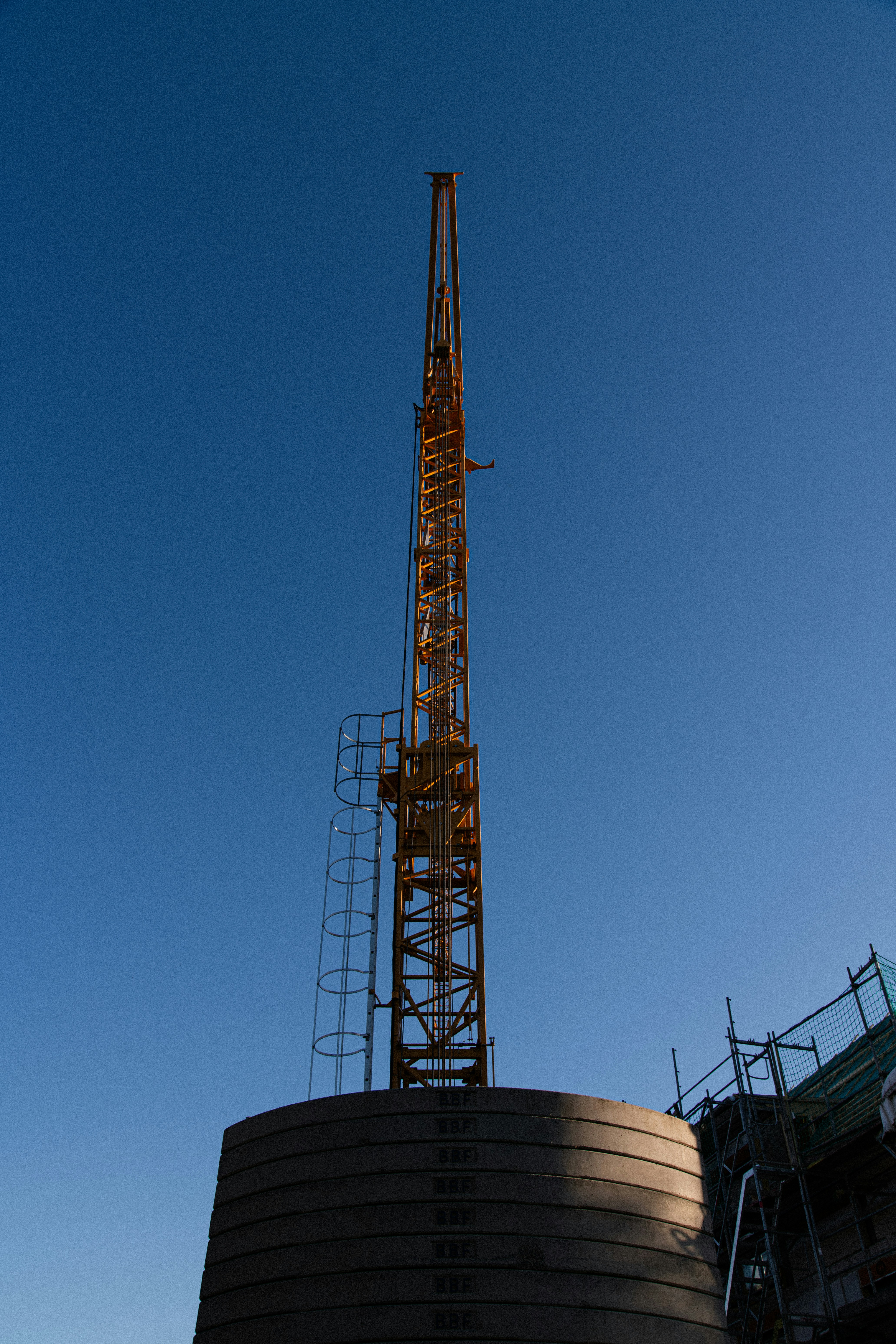 Towering Crane Arises Against a Clear Blue Sky