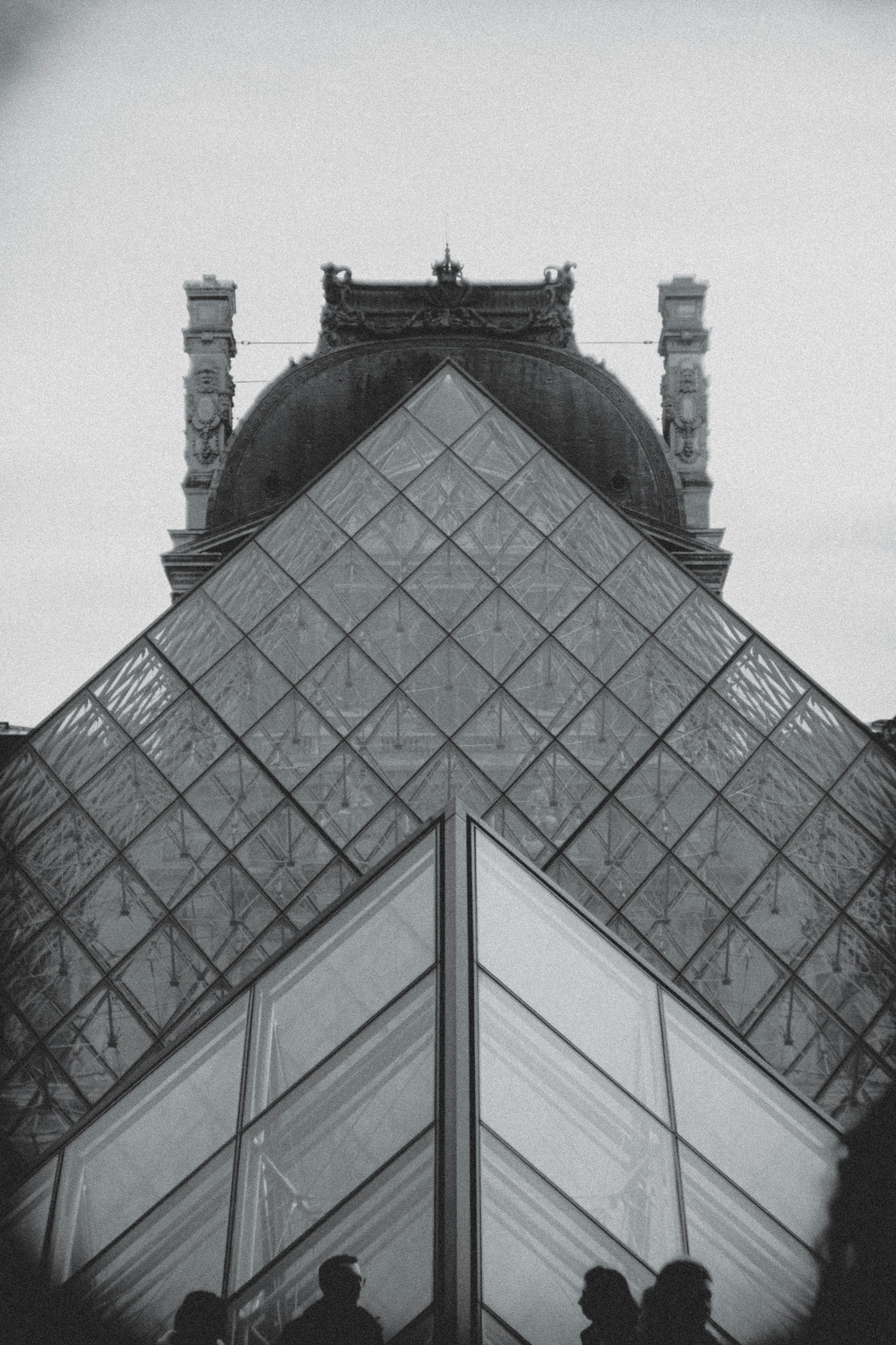 Vitrified Peak: A Pyramid of Glass Amid Historic Rooflines