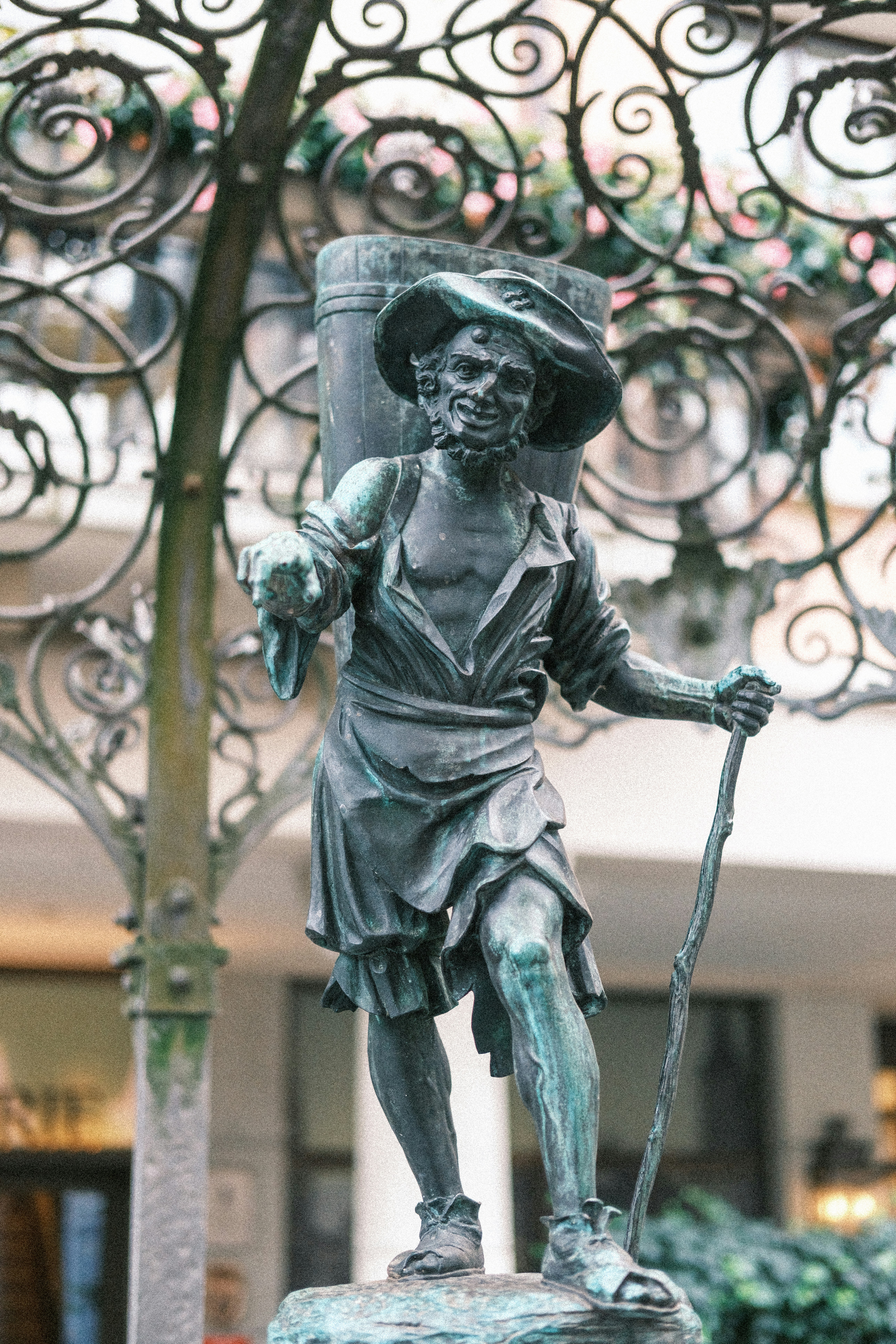 The Wanderer in Bronze: A Dapper Guide Beneath Ironwork