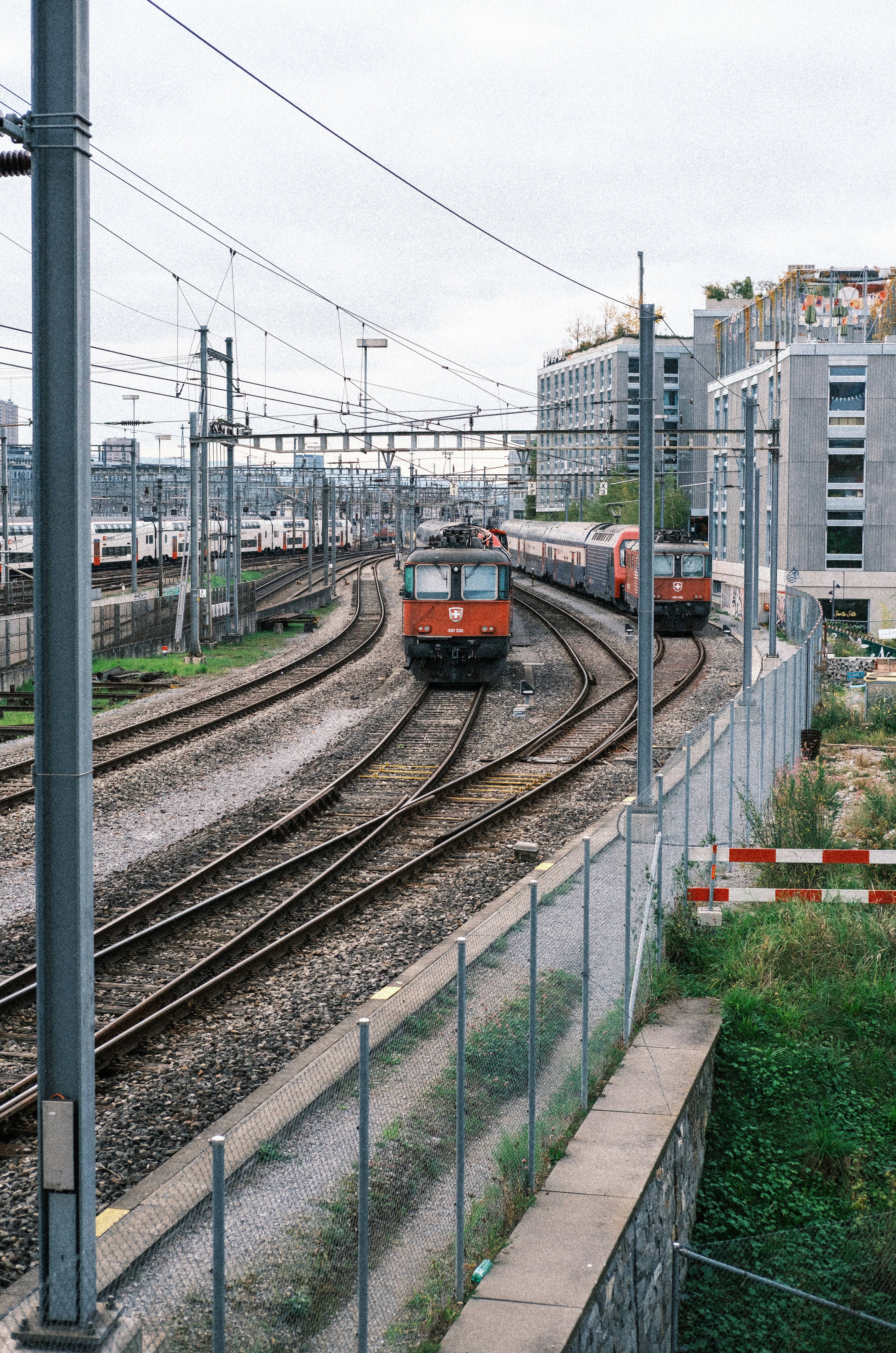 Railway Confluence: A Red Engine Faces the Curved Tracks