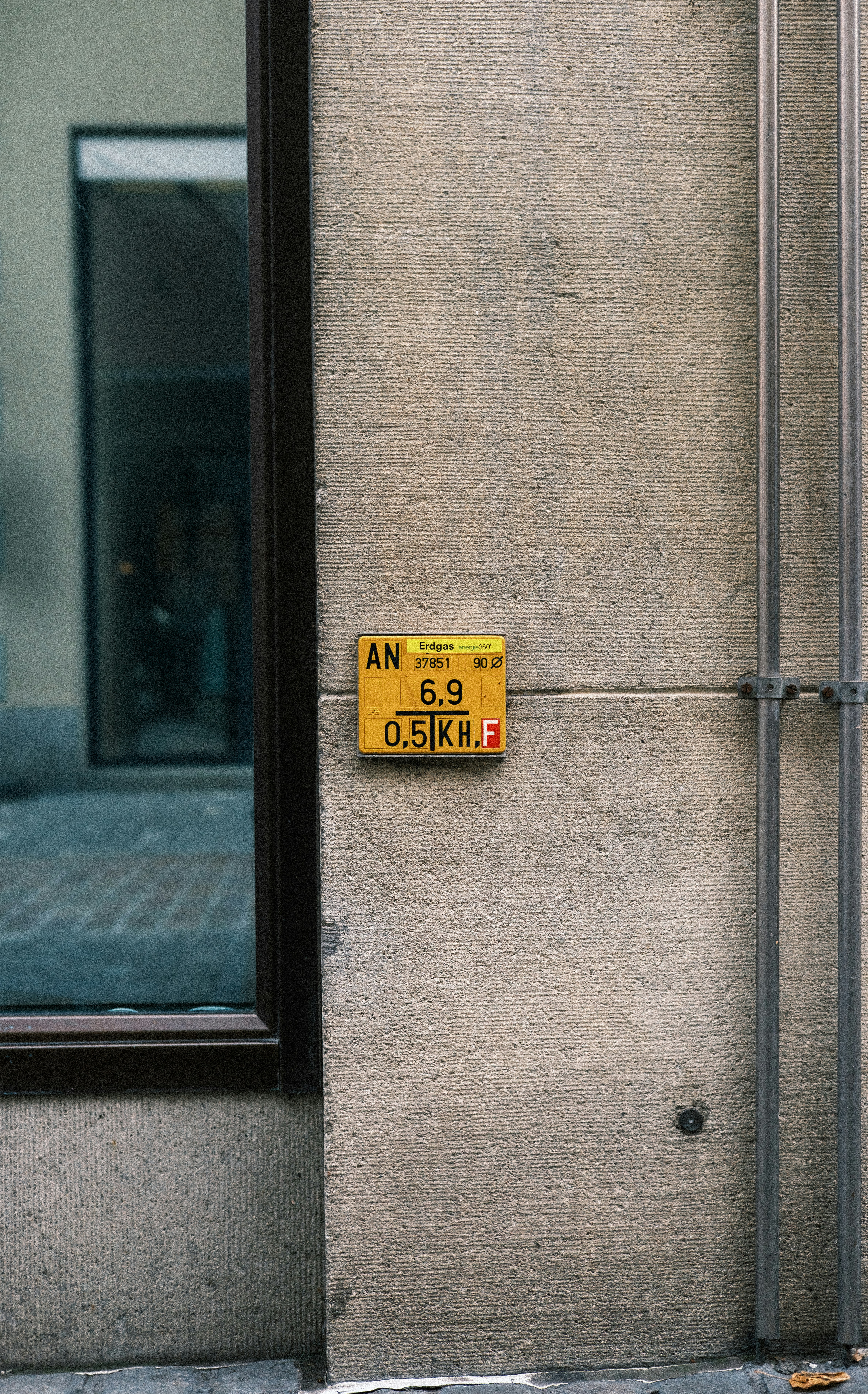 Yellow Sign on a Concrete Wall: An Urban Detail
