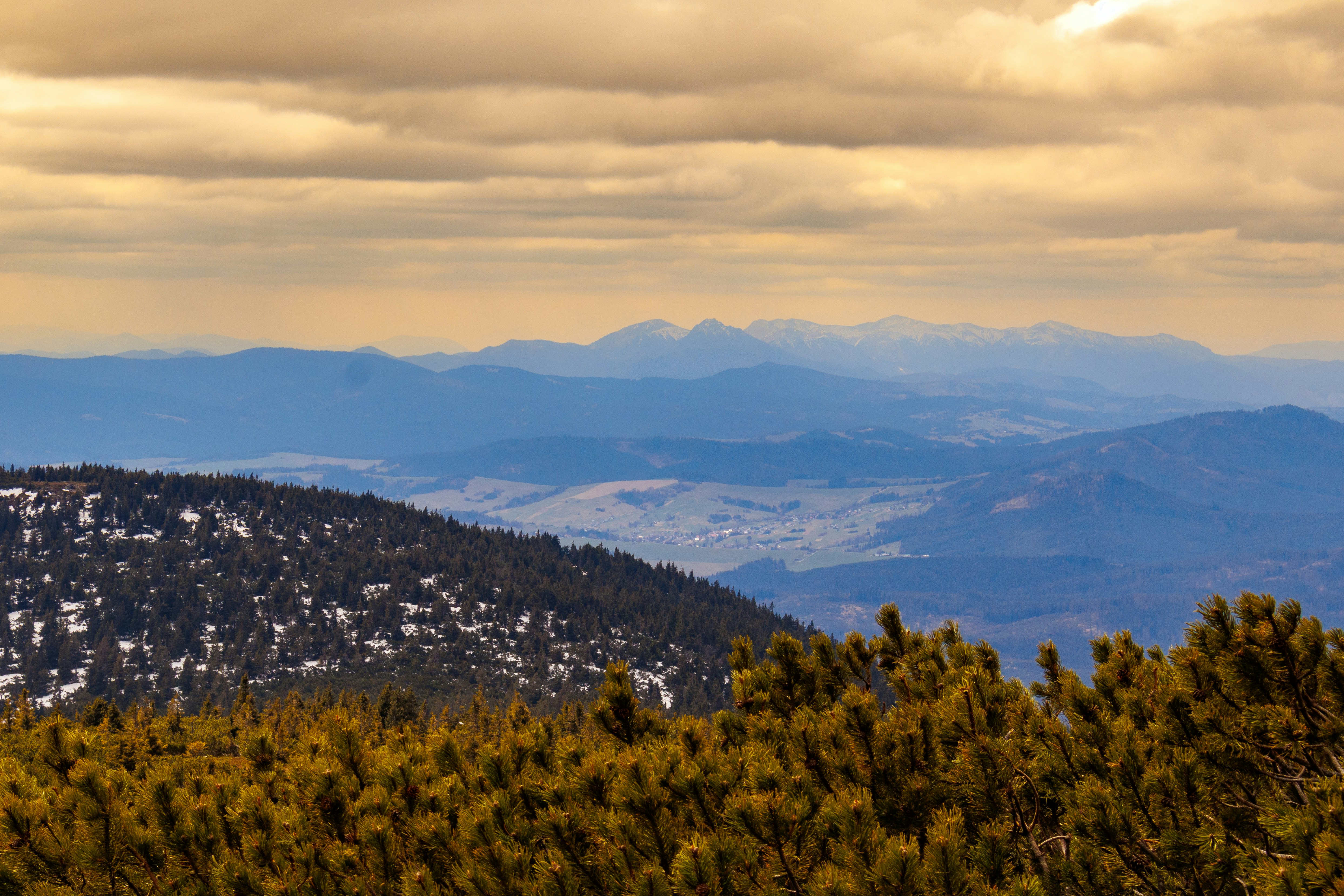 Layered Peaks Across a Golden Sky