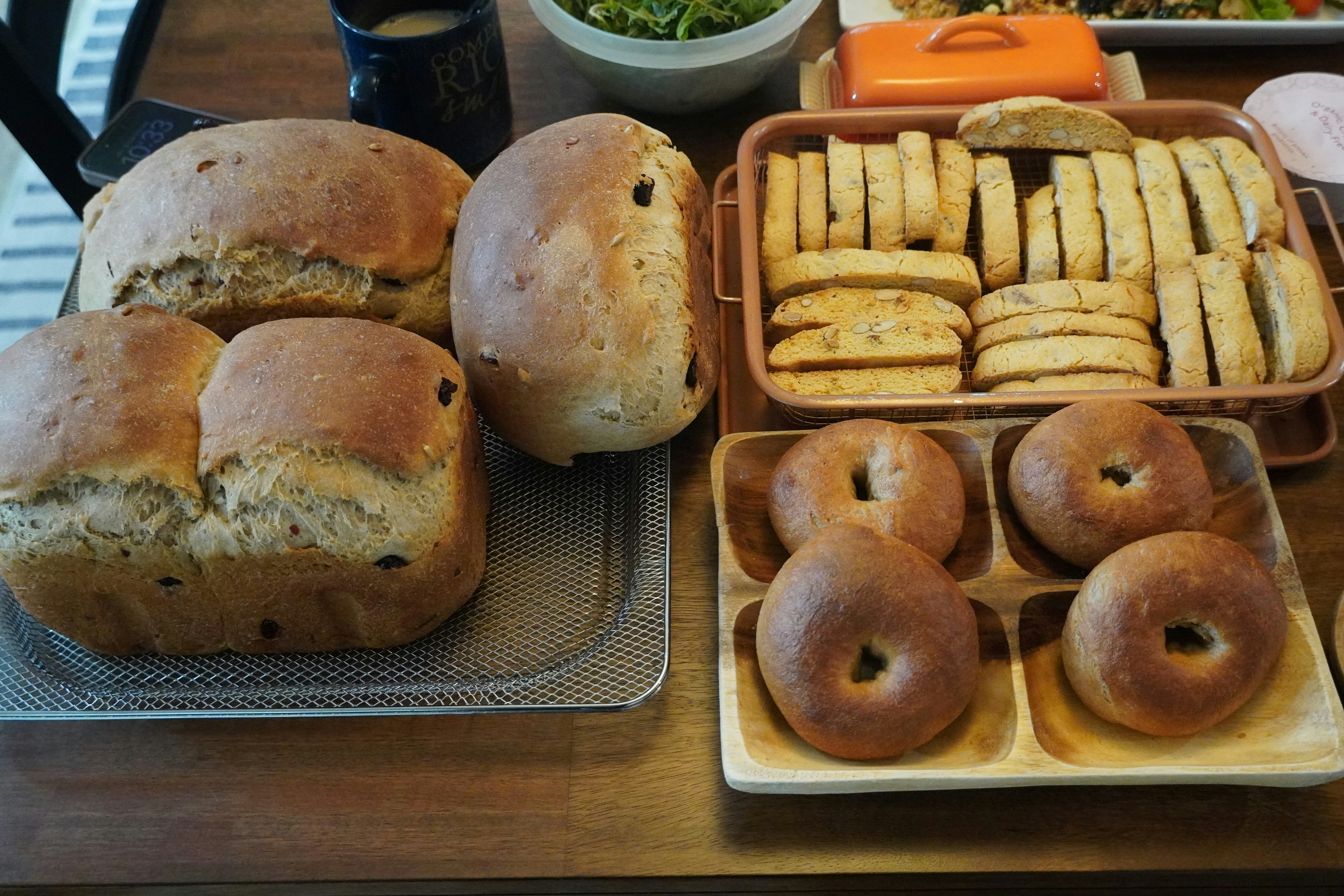 Warm Bakery Spread: Assorted Loaves and Donuts on a Rustic Counter