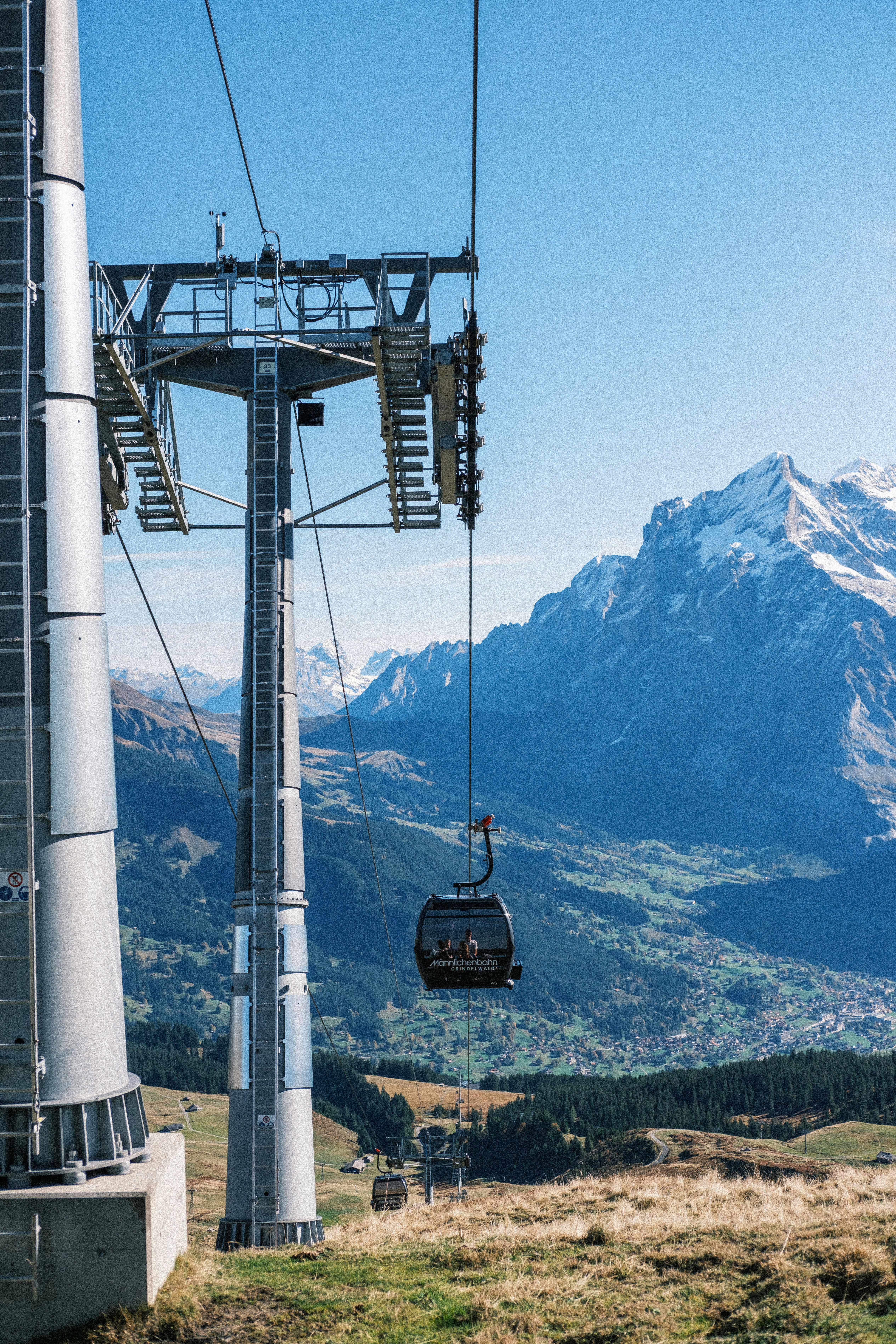 Cable Car Ascent: A Mountain Vista through Steel and Sky