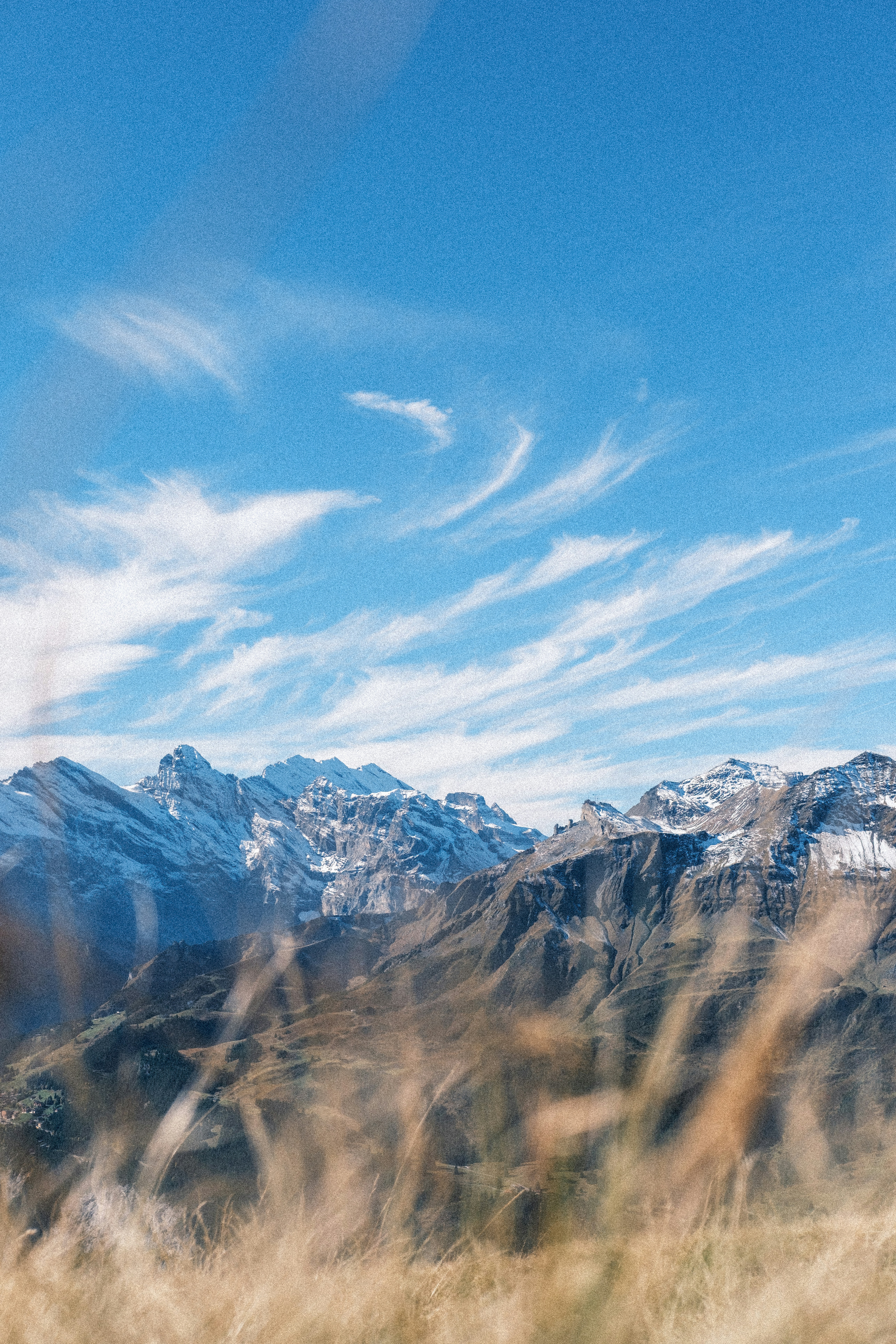 Dawn over Alpine Ridges: Snow-kissed Peaks Beneath a Cerulean Sky