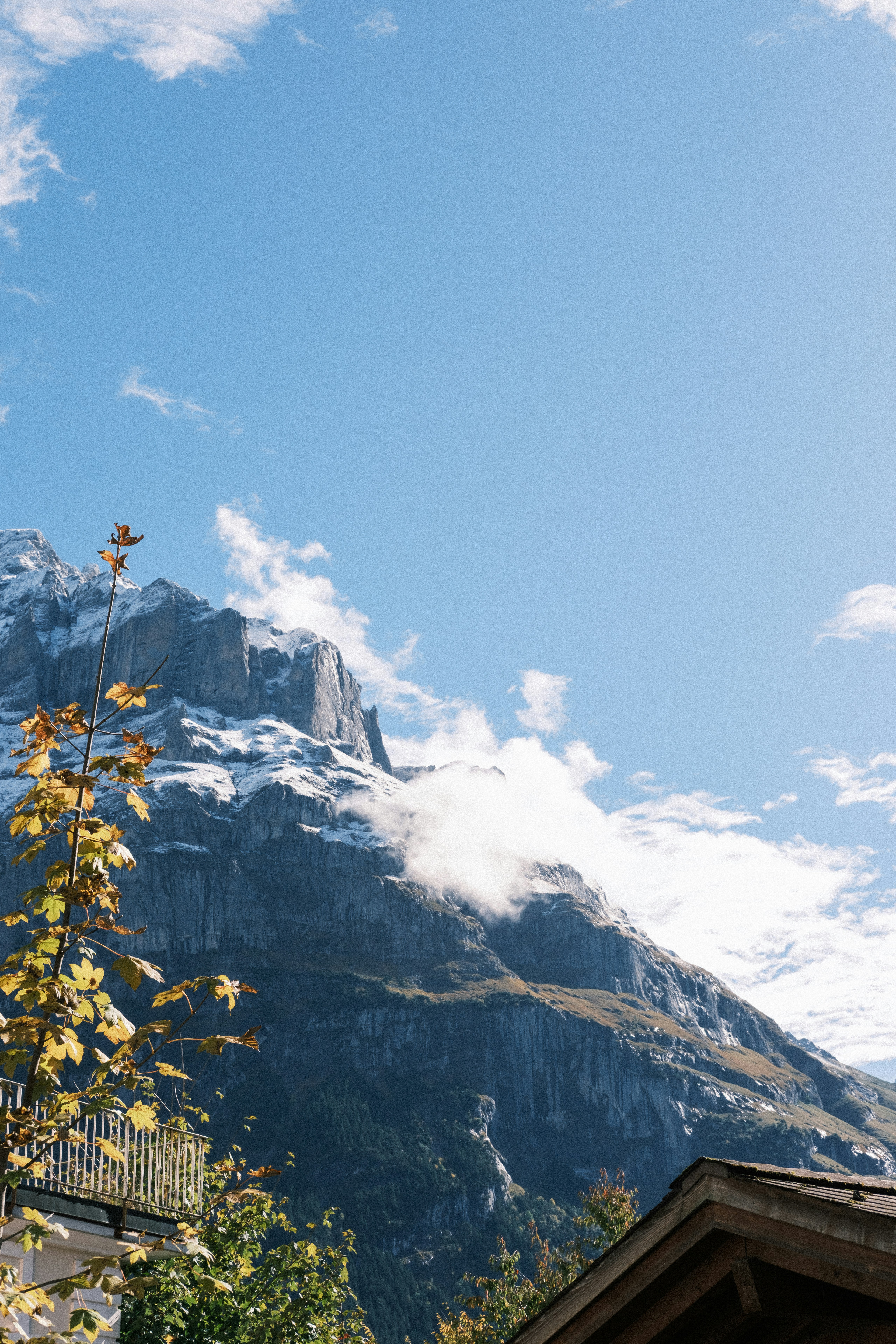 Rugged Alpine Face beneath a Clear, Expansive Sky