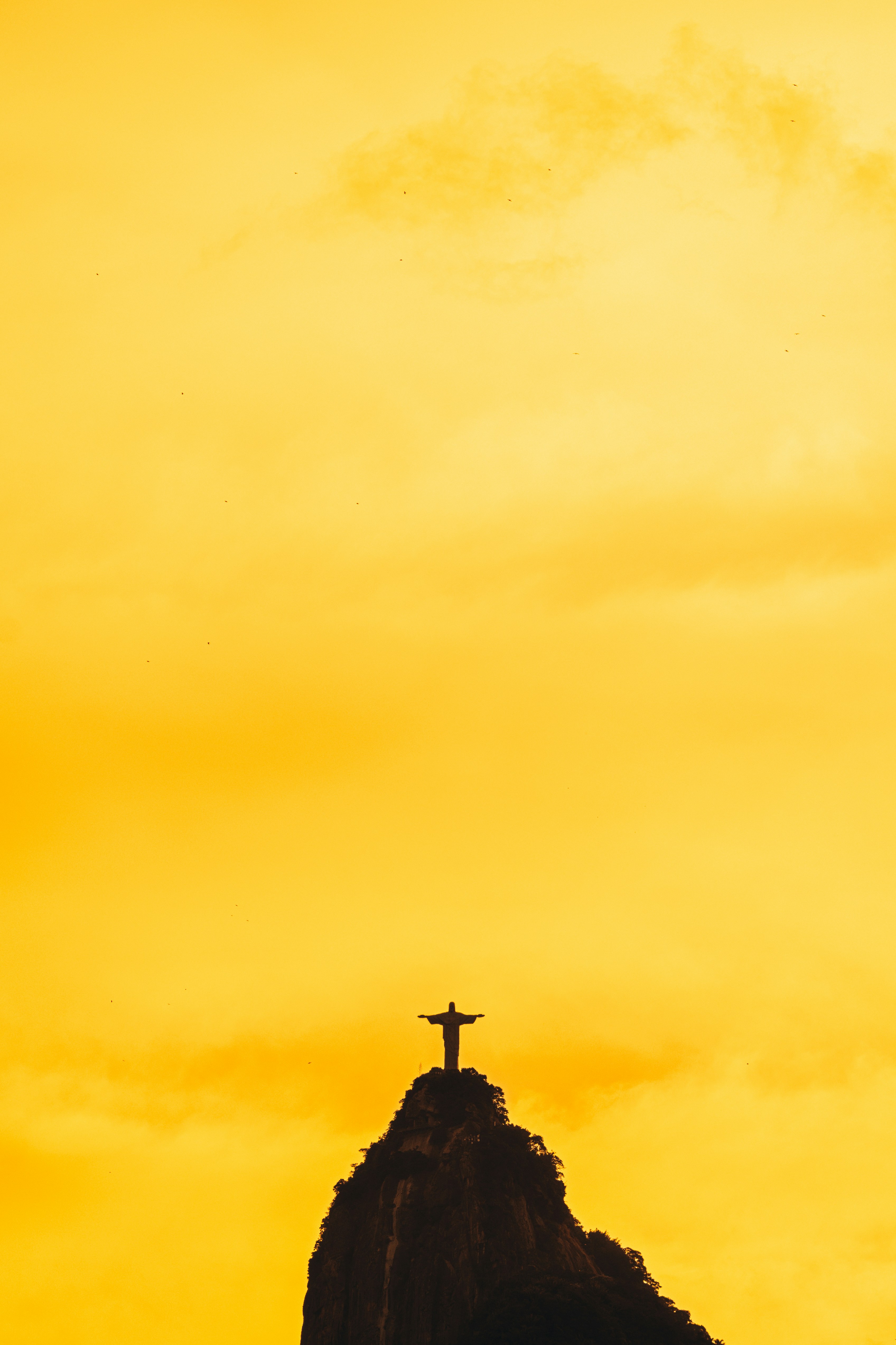 Sunset Silhouette of a Crowned Peak with a Cross