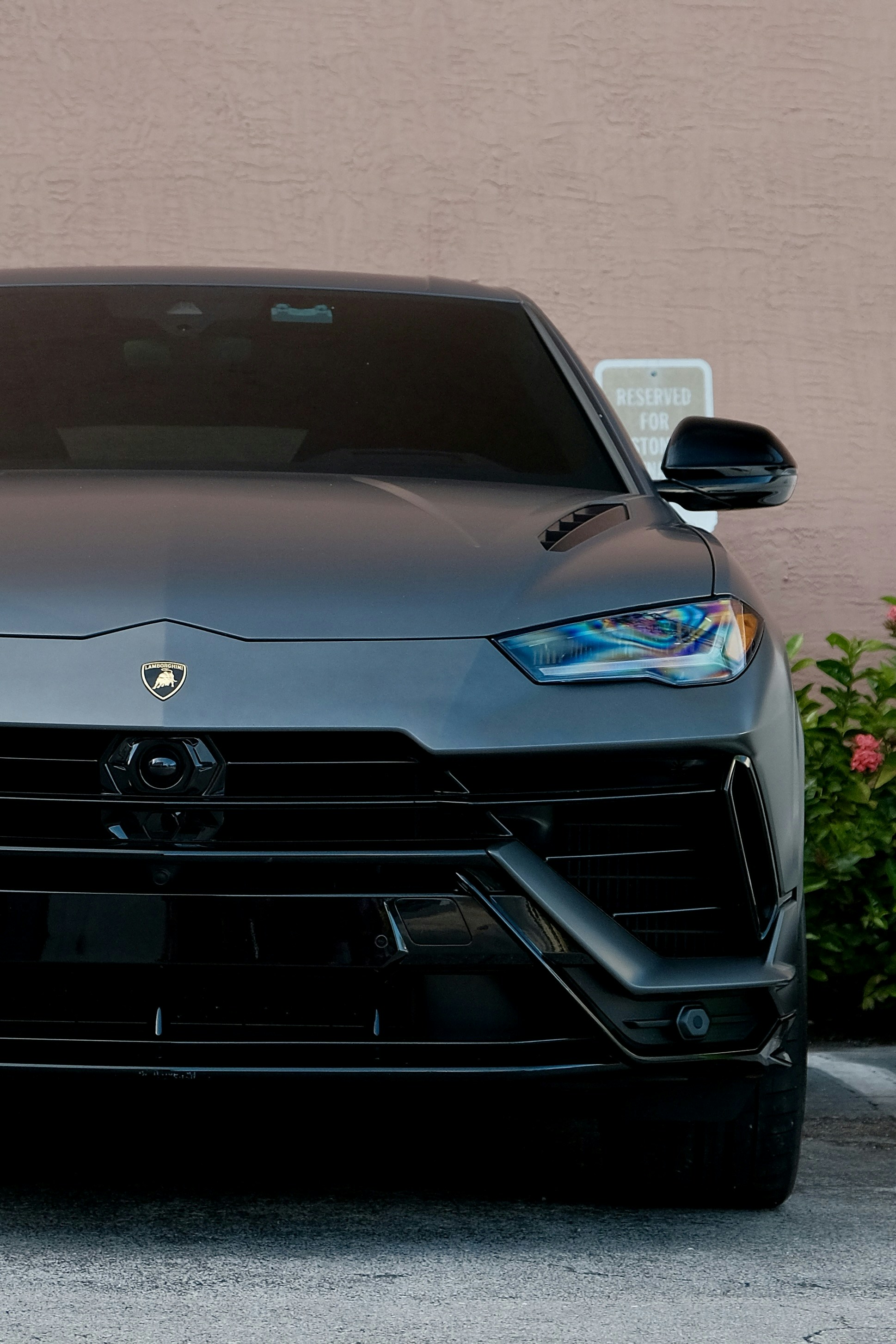 Midday confrontation: a menacing front view of a grey Lamborghini SUV ready to pounce