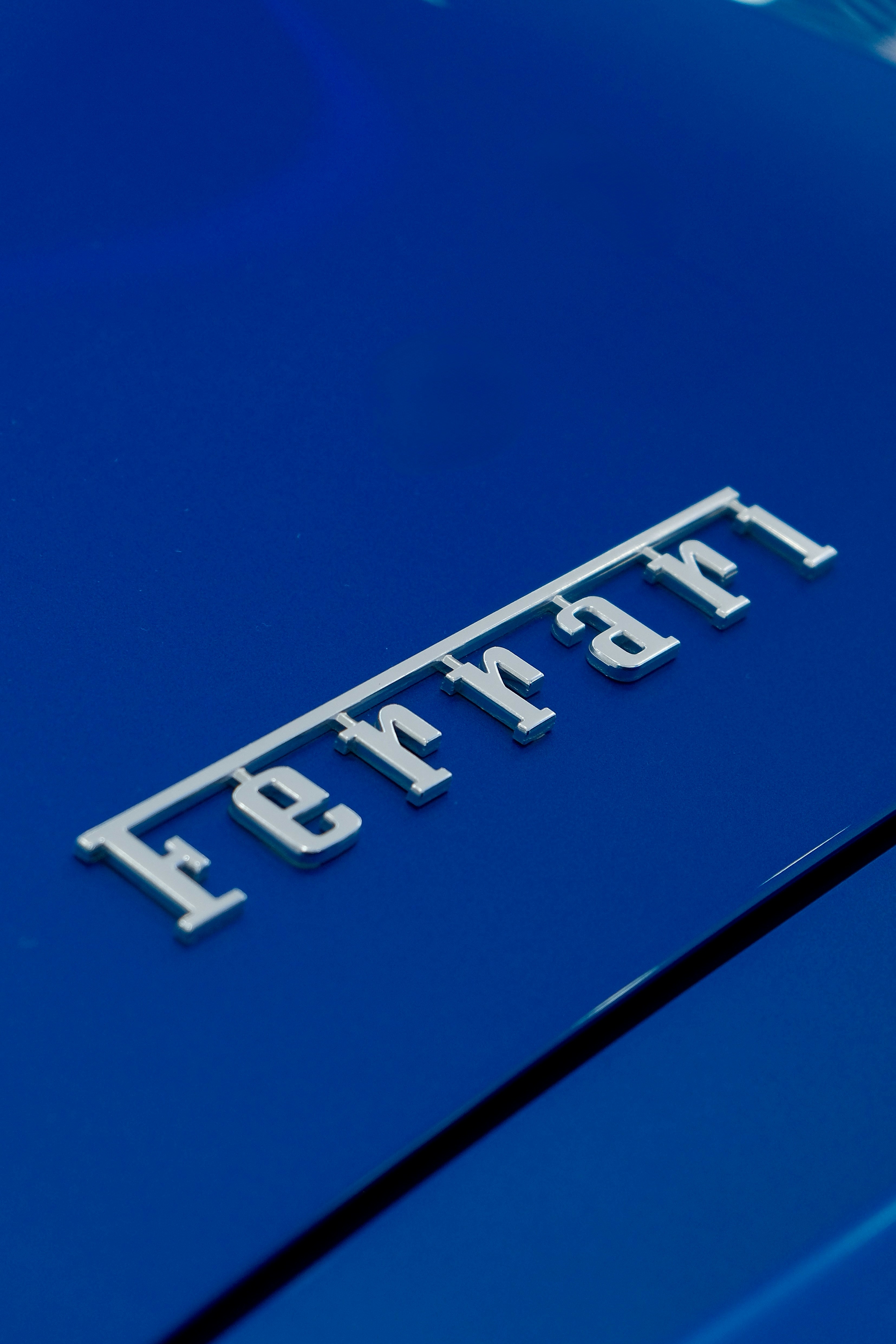 Azure Curves: The Ferrari Emblem on a Glossy Surface