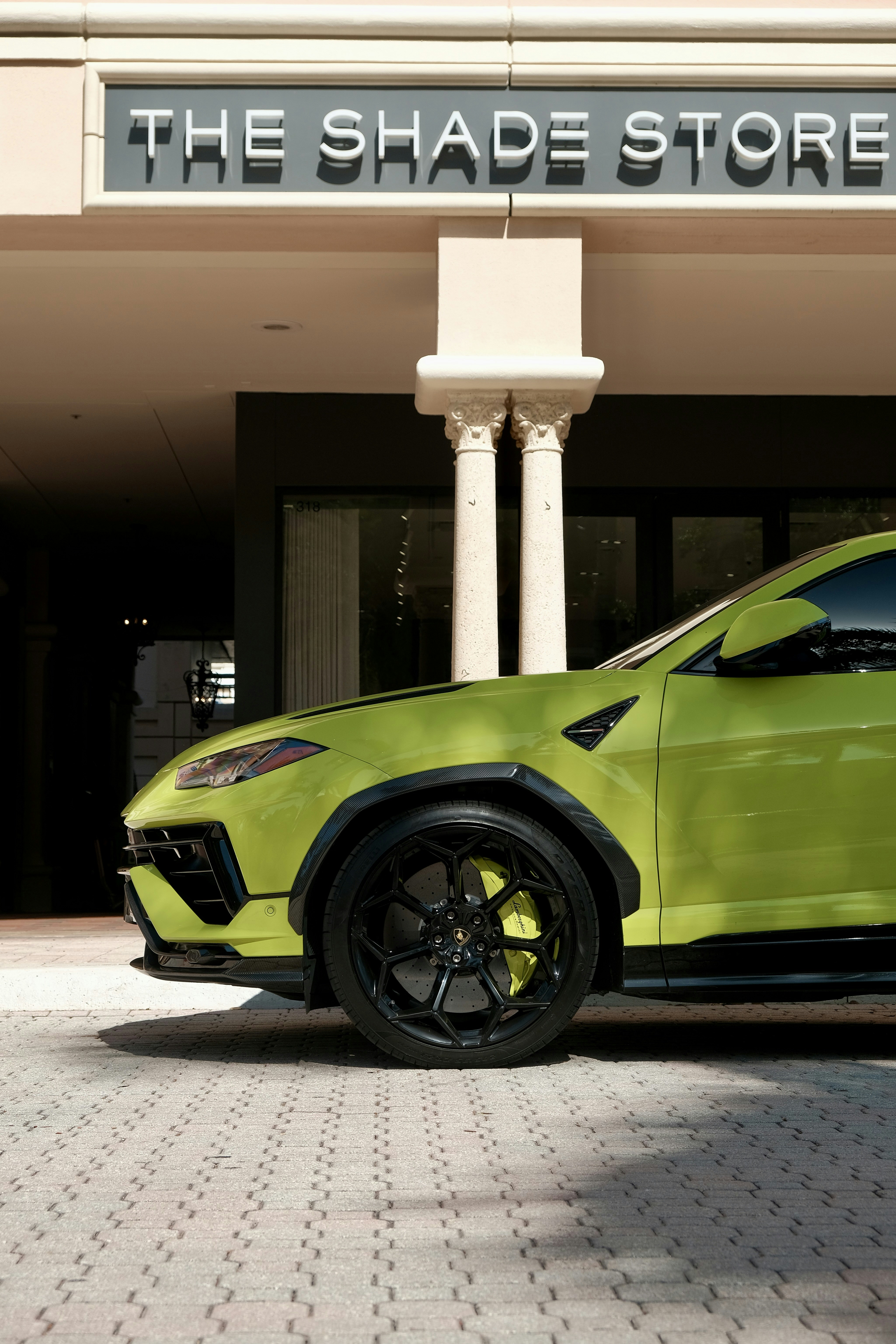 Lime Pulse: A neon-green sedan anchors the storefront façade