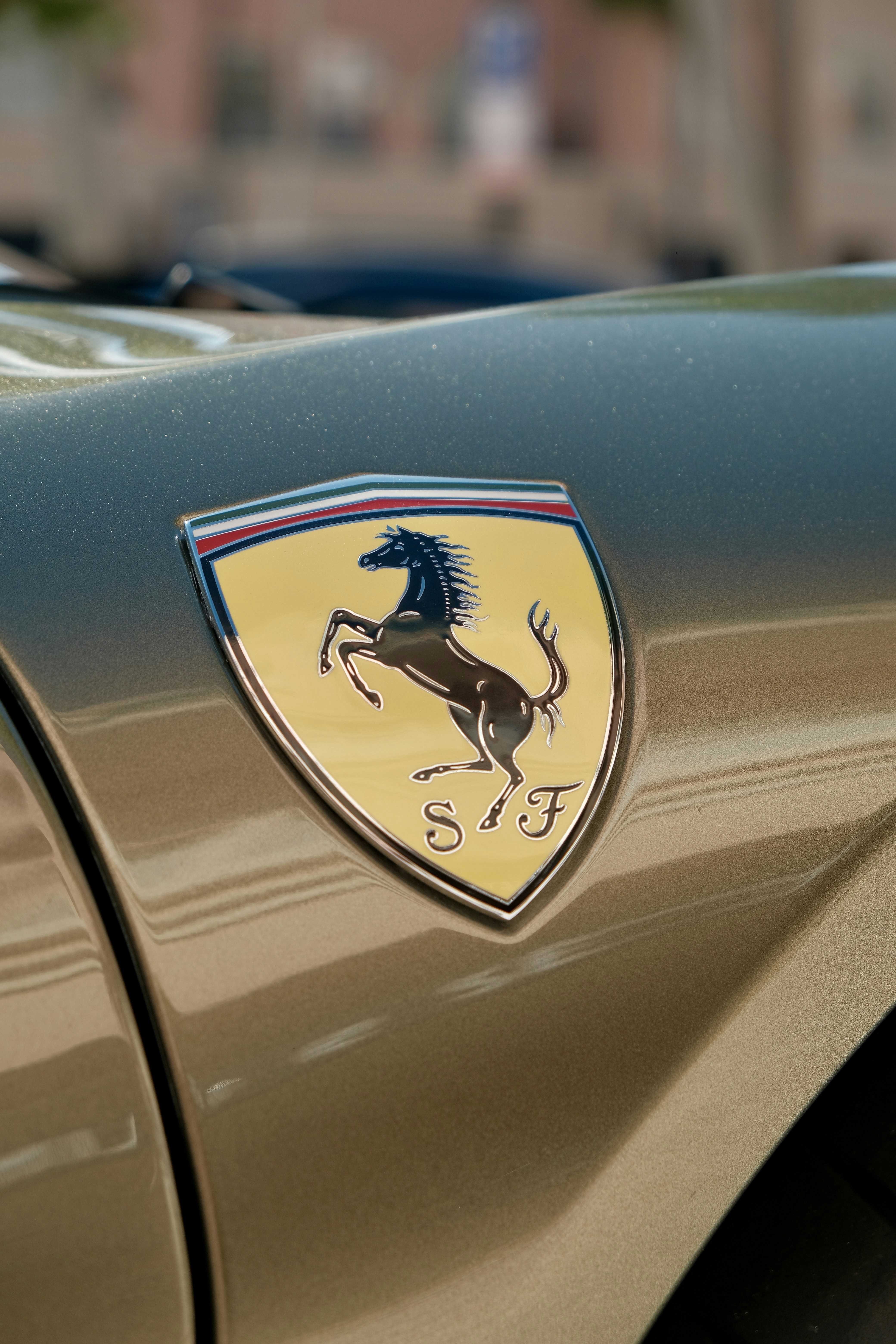 Emblem in Focus: A Pristine Ferrari Crest on metallic Green