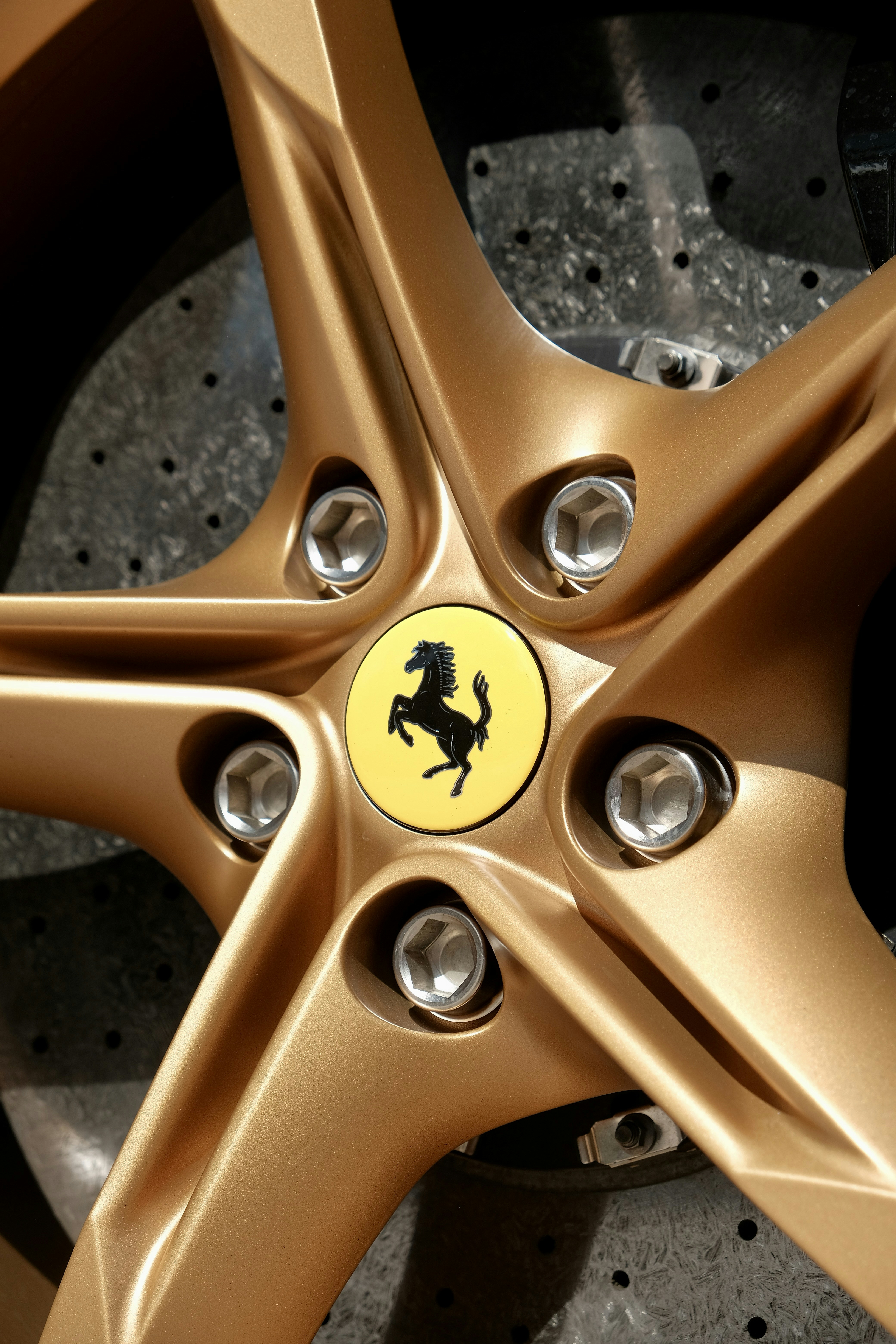 Golden Wheel: Ferrari Crest on a Bronze Rim