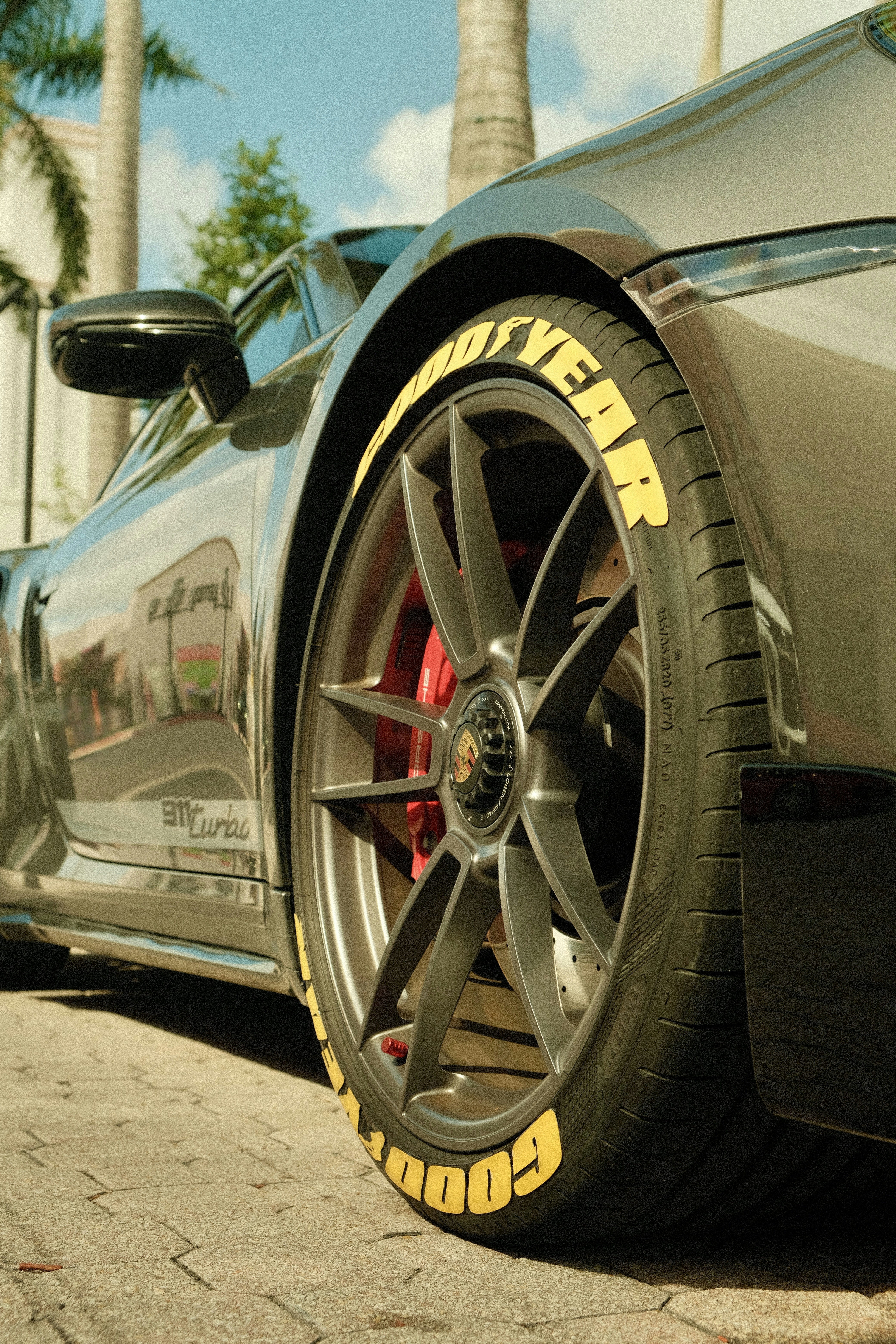 Low-angle race-inspired close-up of a vented wheel and tire