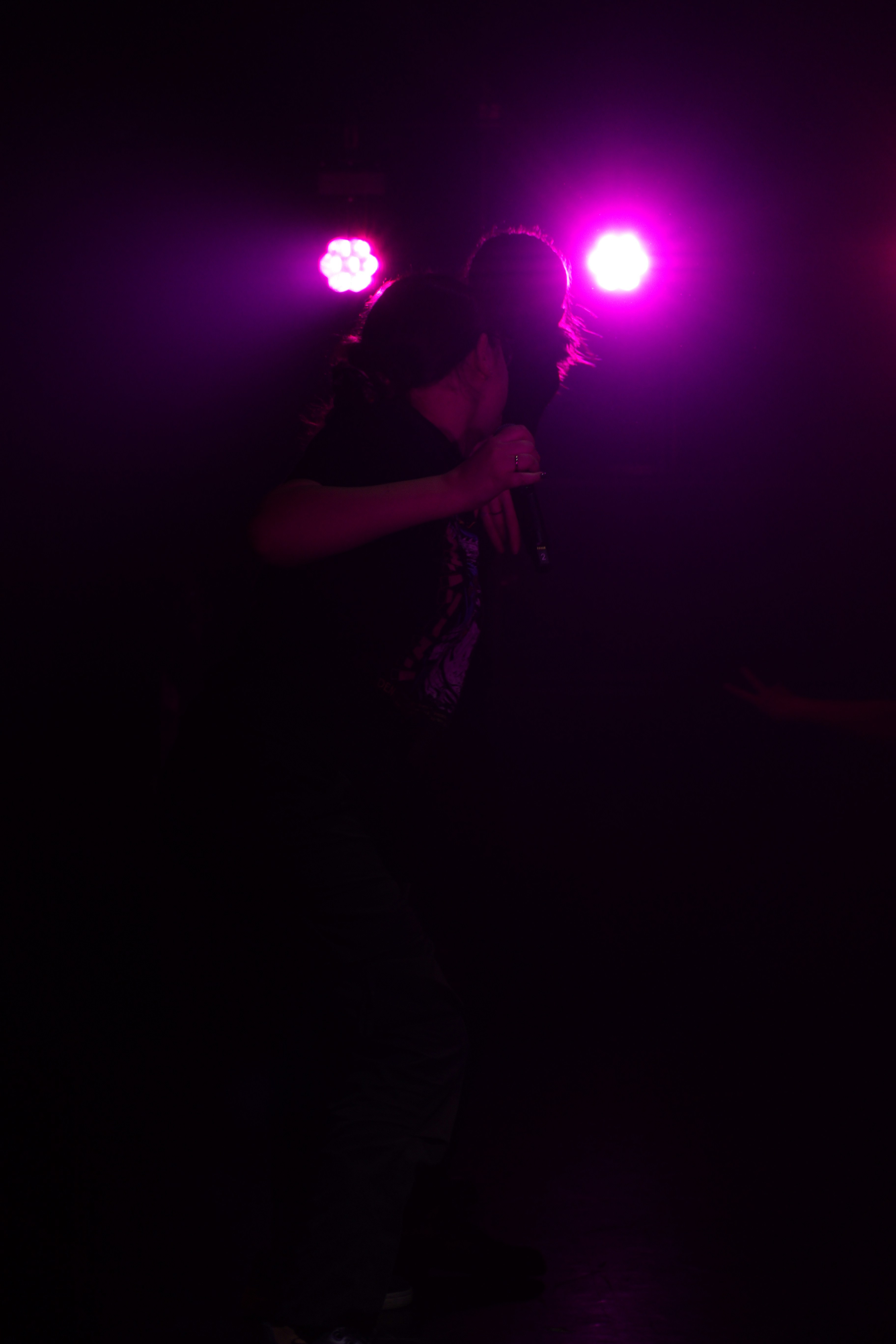 Midnight duet under magenta stage lights