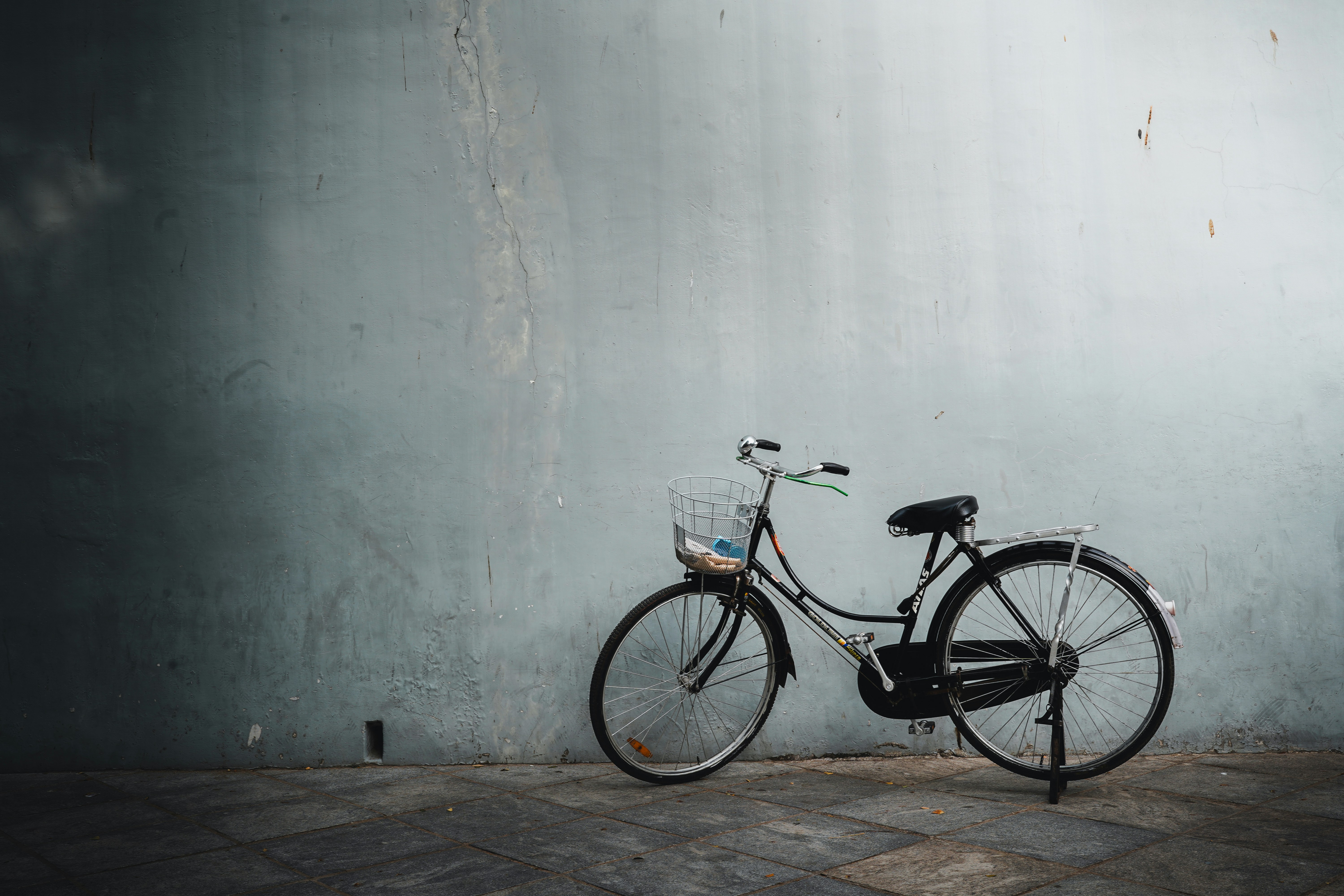 Lonely Cyclist: A Standalone Bike by a Weathered Wall