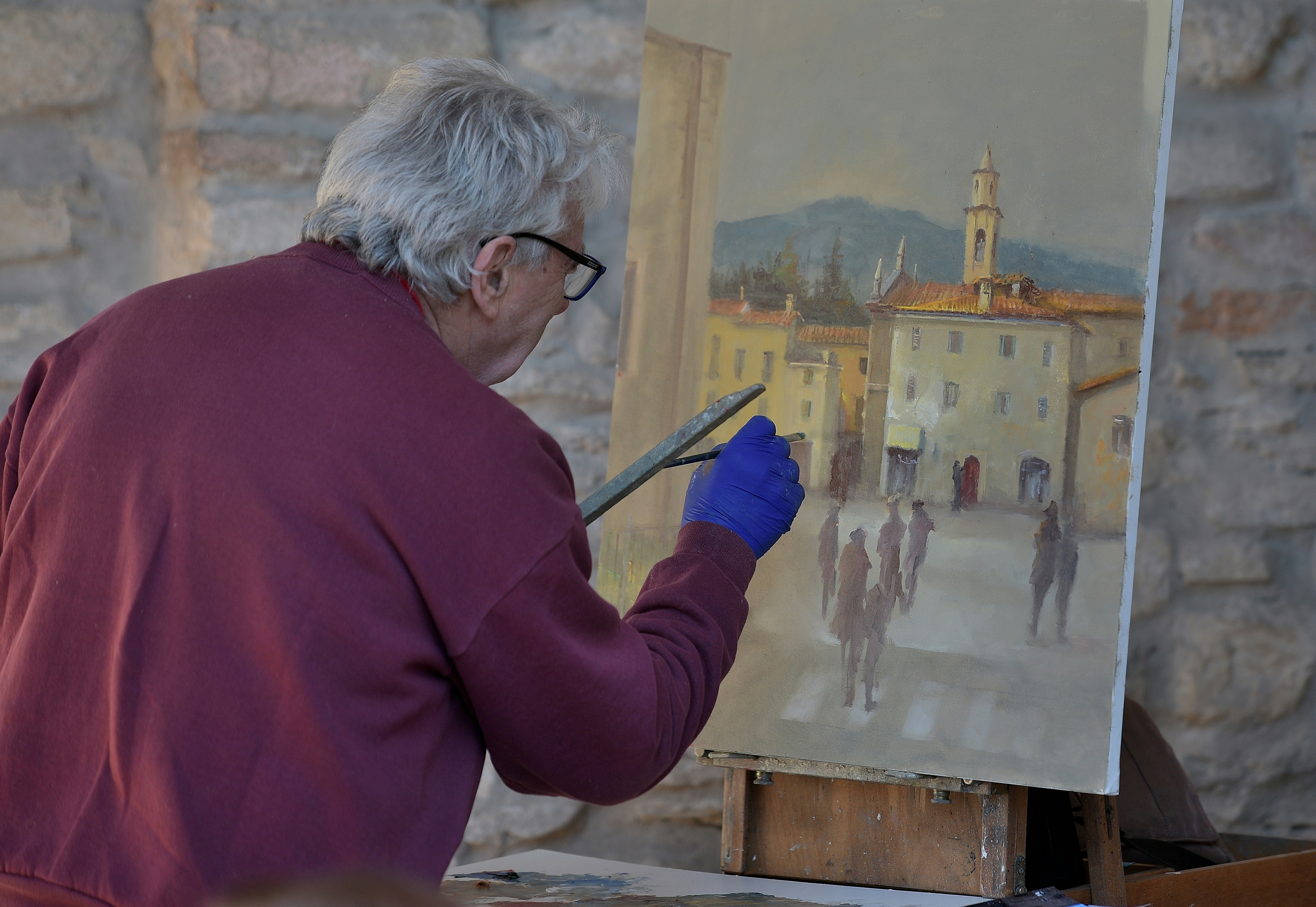 The Painter Before a Stone Town: An Outdoor Studio in Warm Light