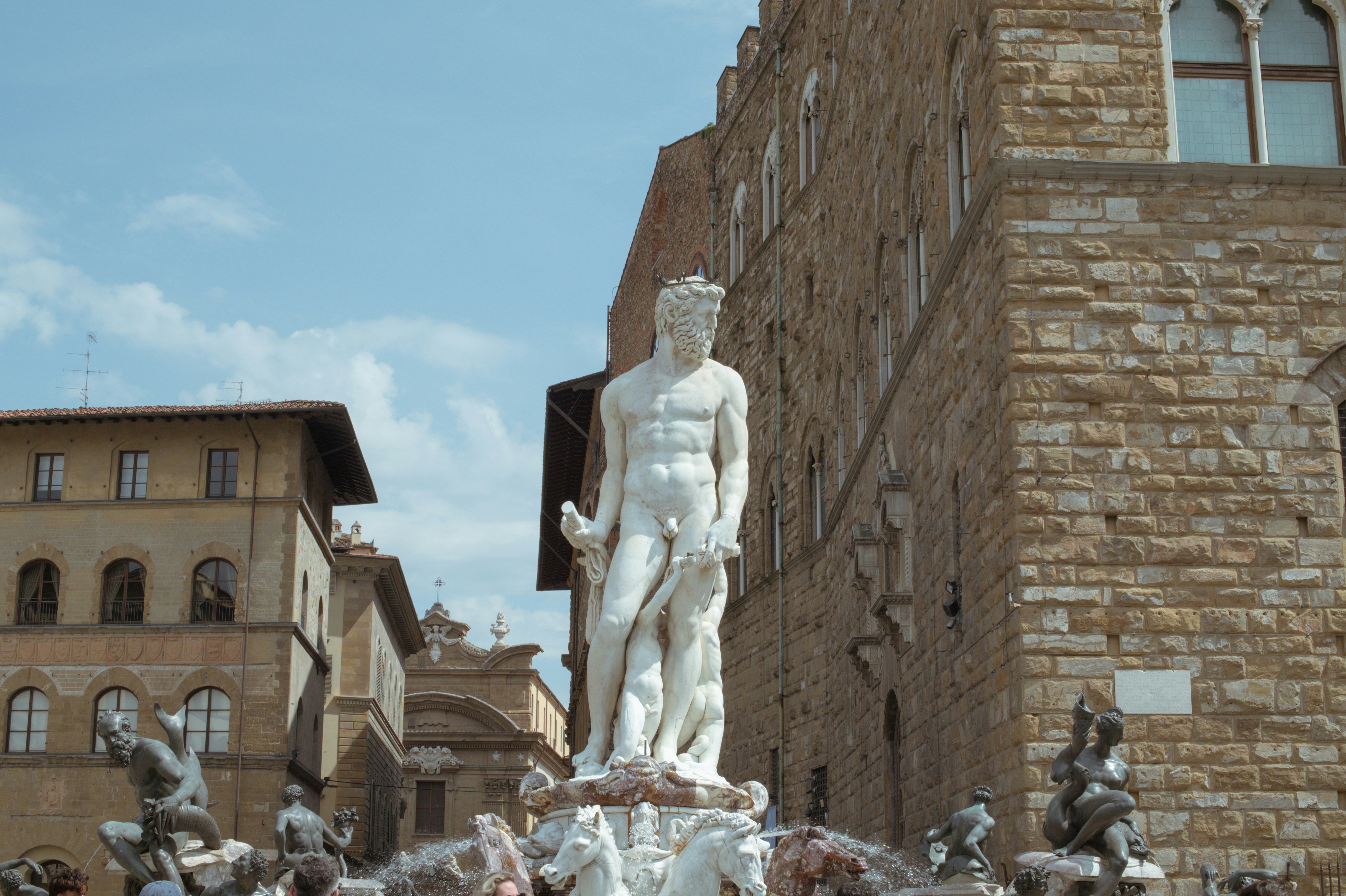Fountain Statue Framed by Historic Facades in Piazza