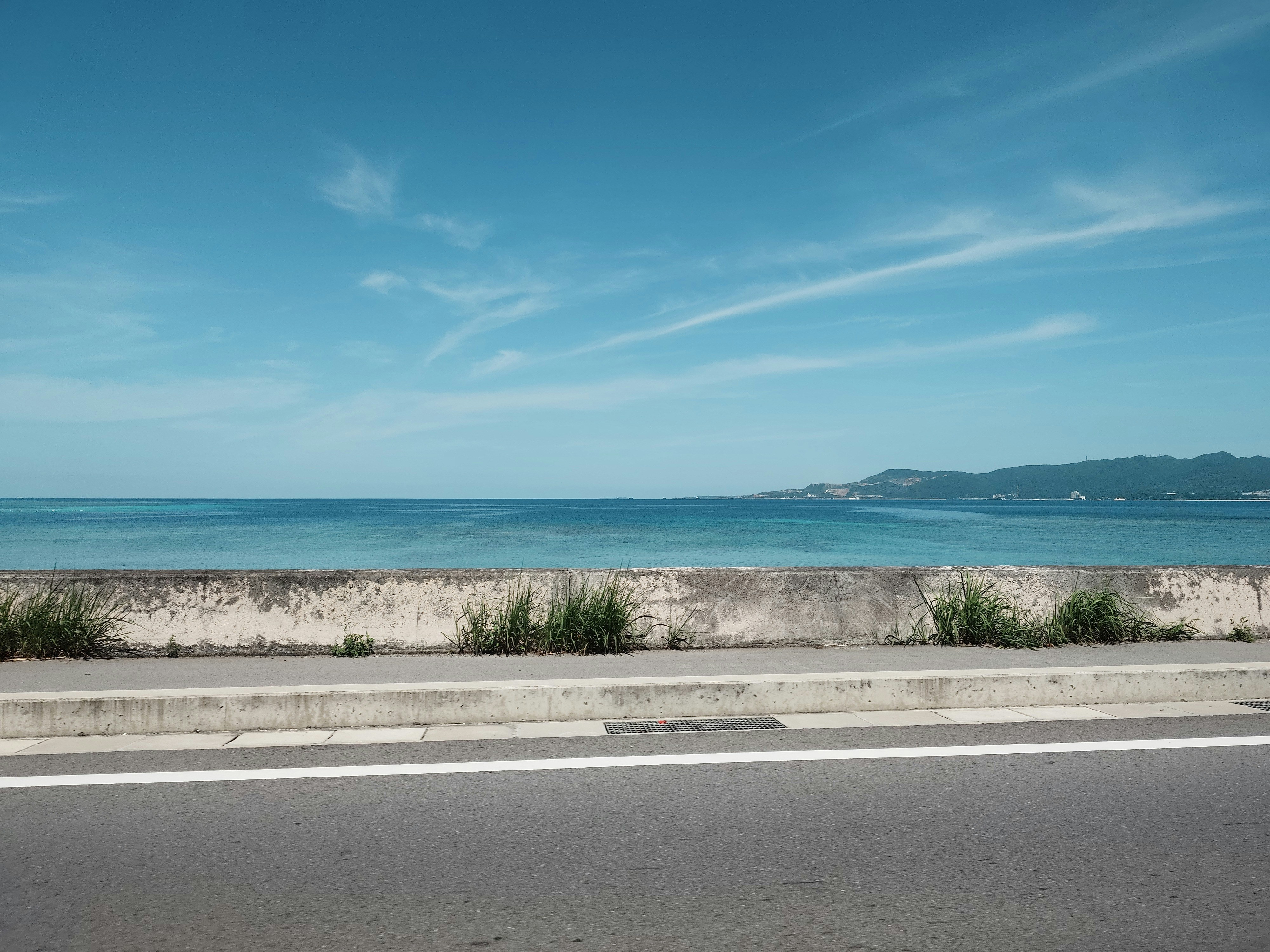 Seaside Roadside Calm: A Quiet Horizon by the Sea Wall