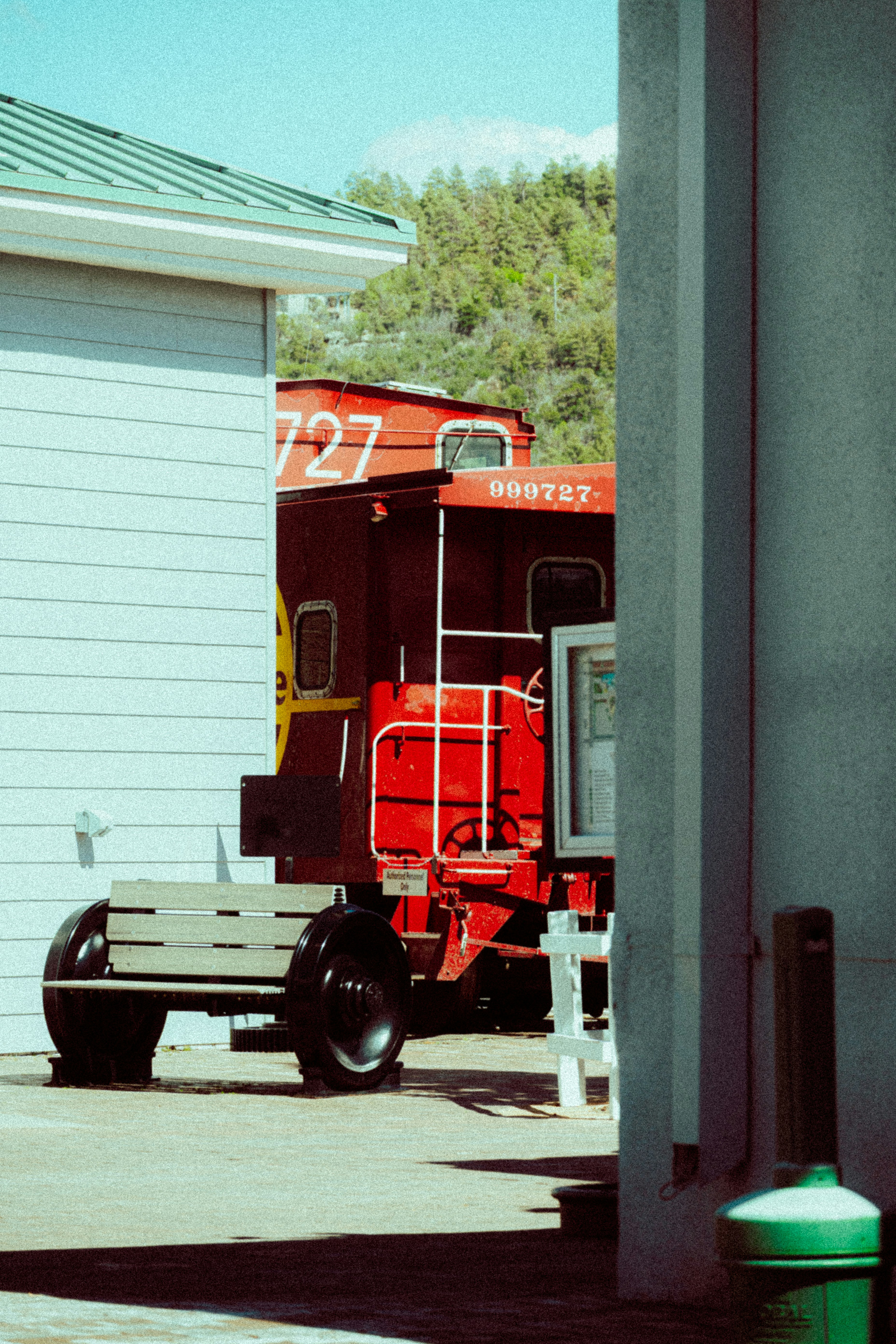 Red Engine in the Side Yard: A Quiet Train Car Behind a Shed