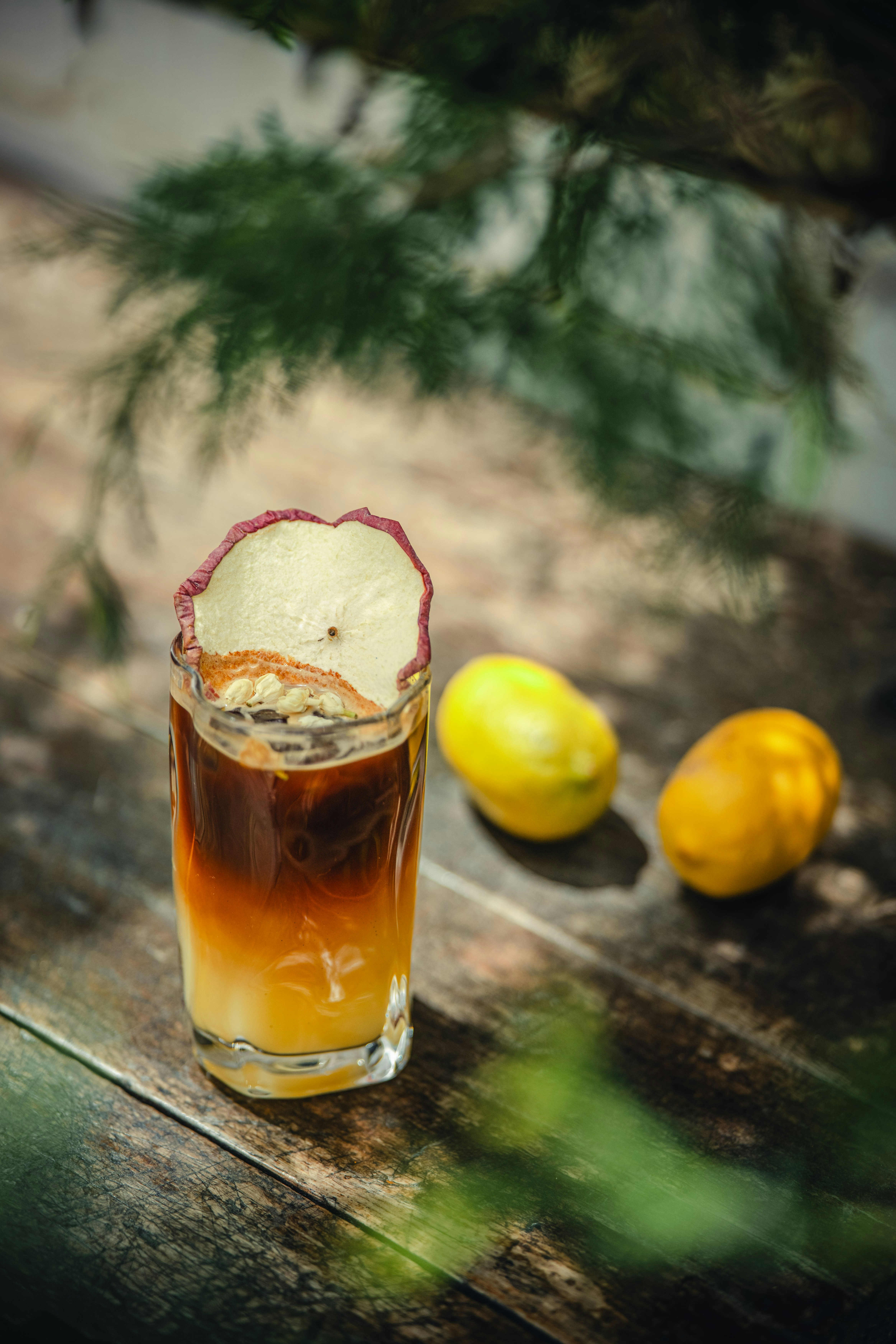 Tropical cocktail on a rustic table with citrus backdrop