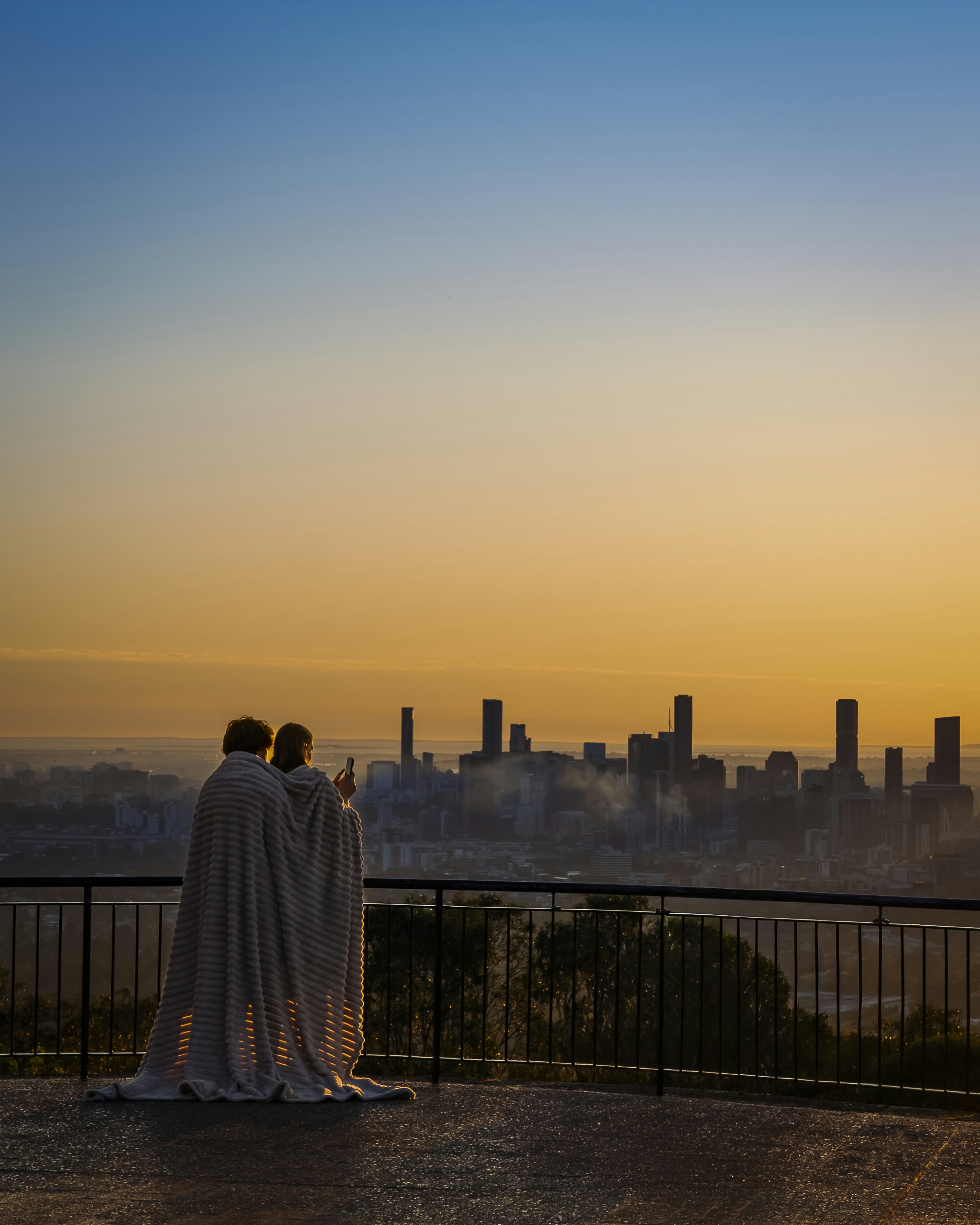Sunset Silhouettes: A Shared Moment Over the City