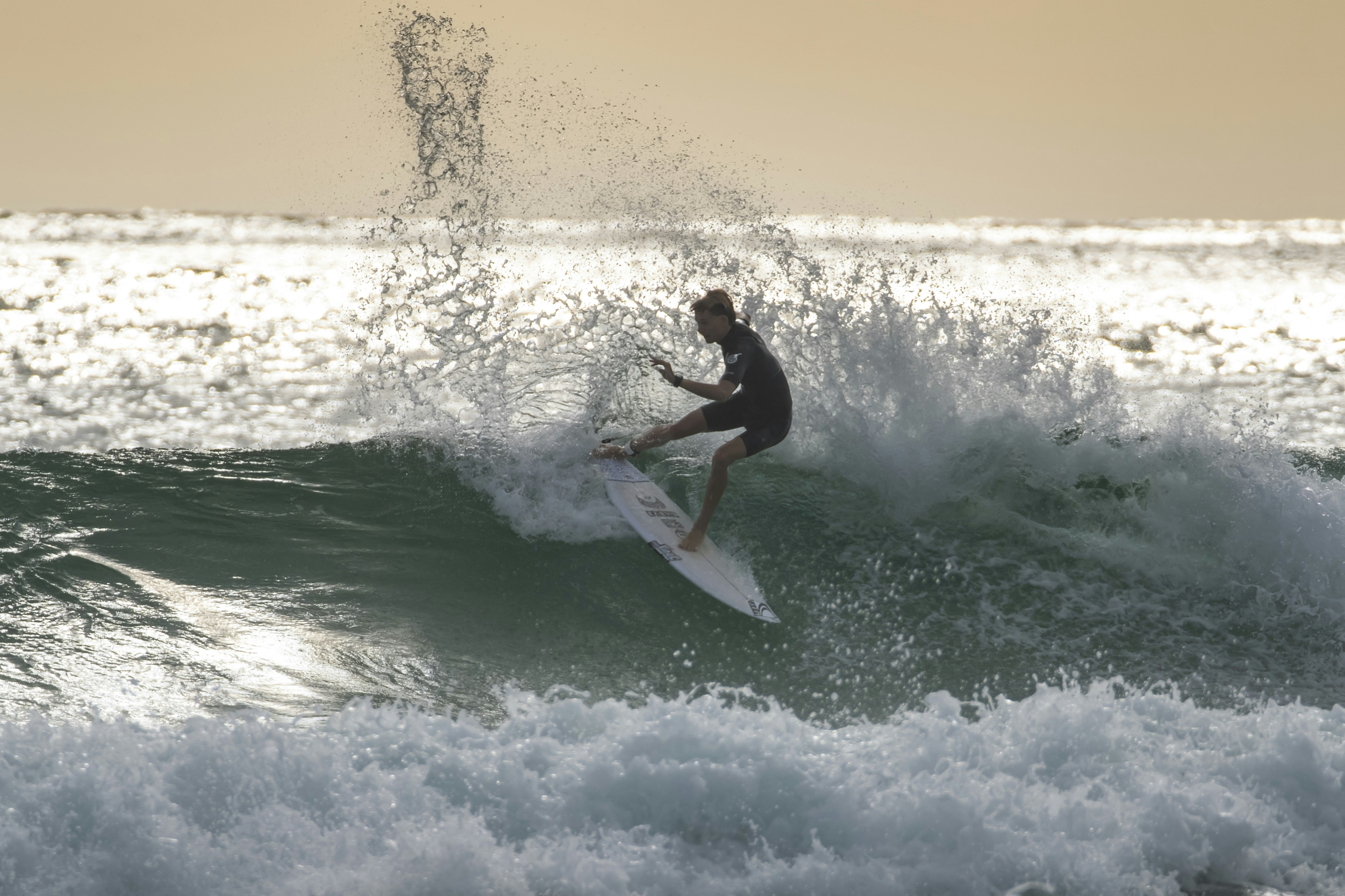Rider in the Crest: A Surfer Carving Through an Ocean Wall