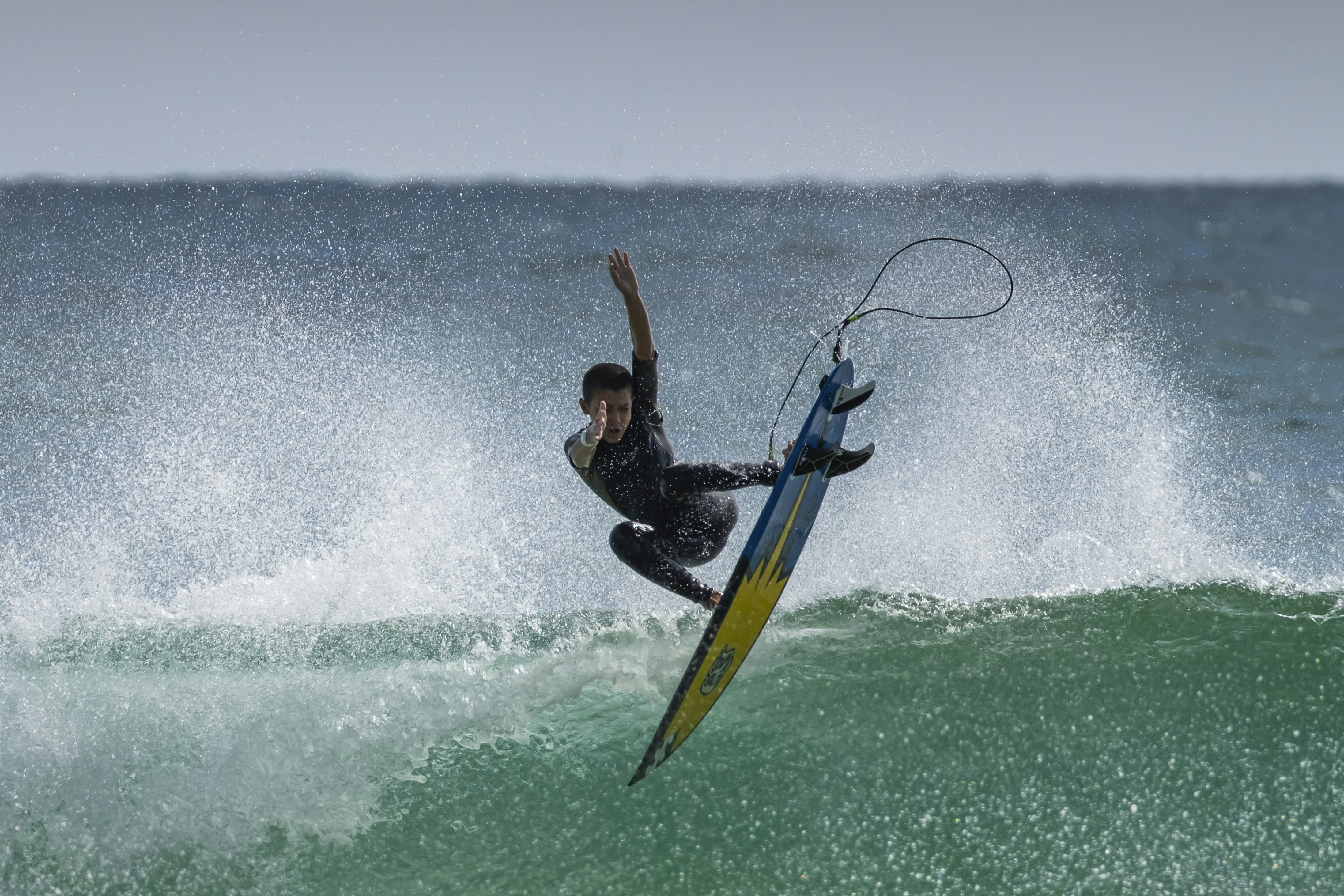 Airborne Foam: A Windsurfer Defies the Wave Crest