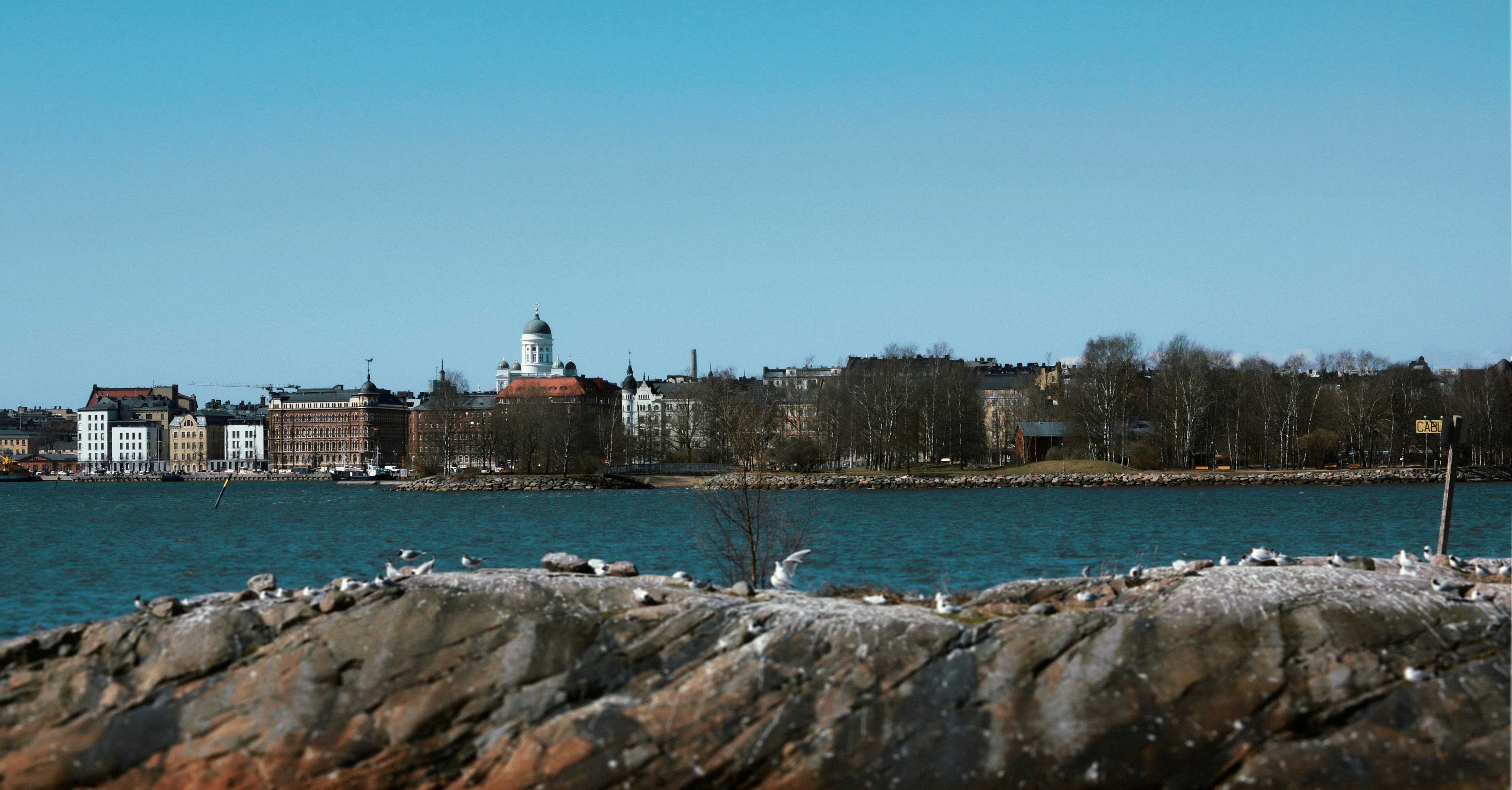 Lakeside City Horizon: Stone Breaker at the Waterfront