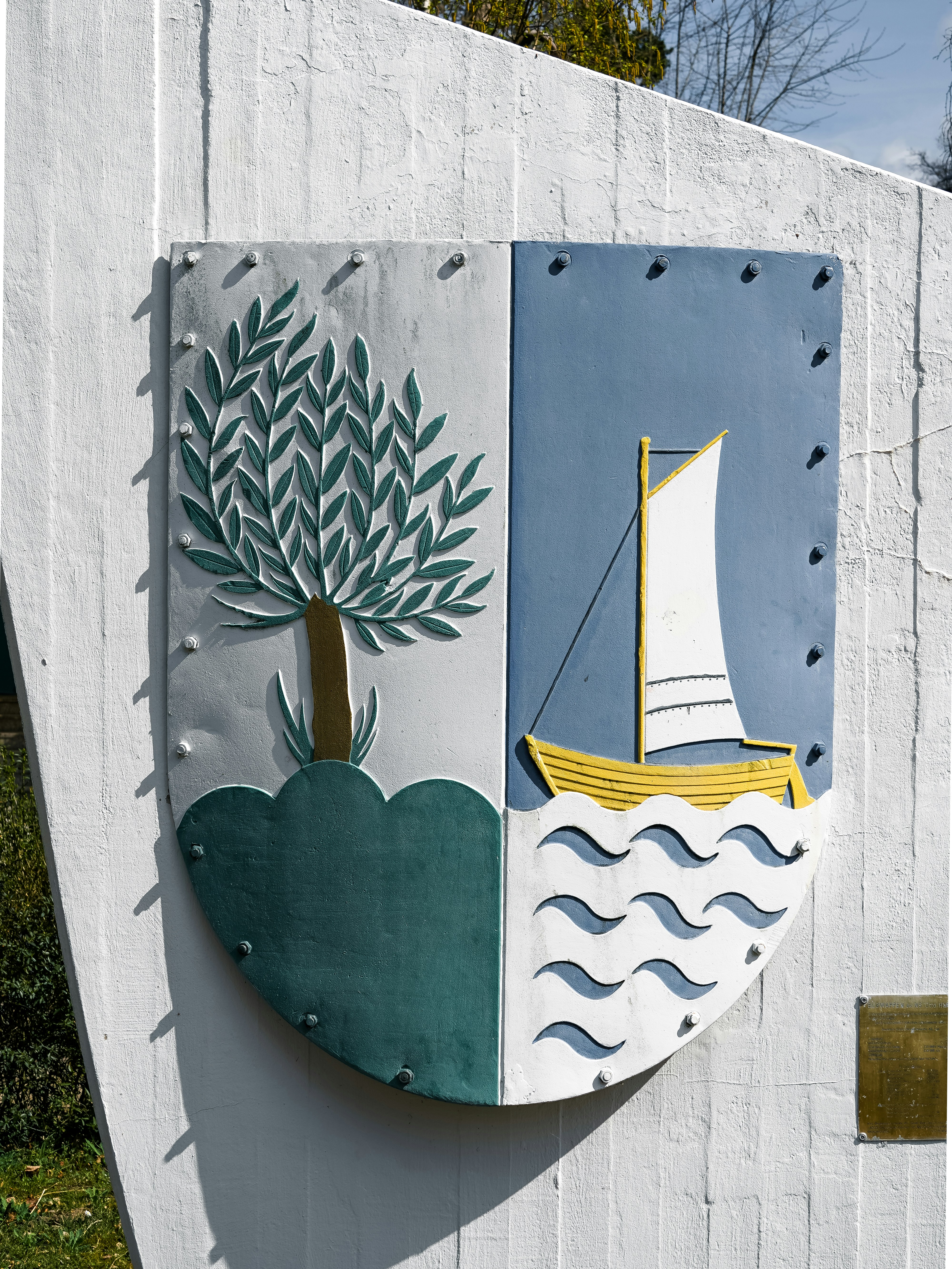 Shielded Harbor: A Decorative Crest Emerges from a White Wall