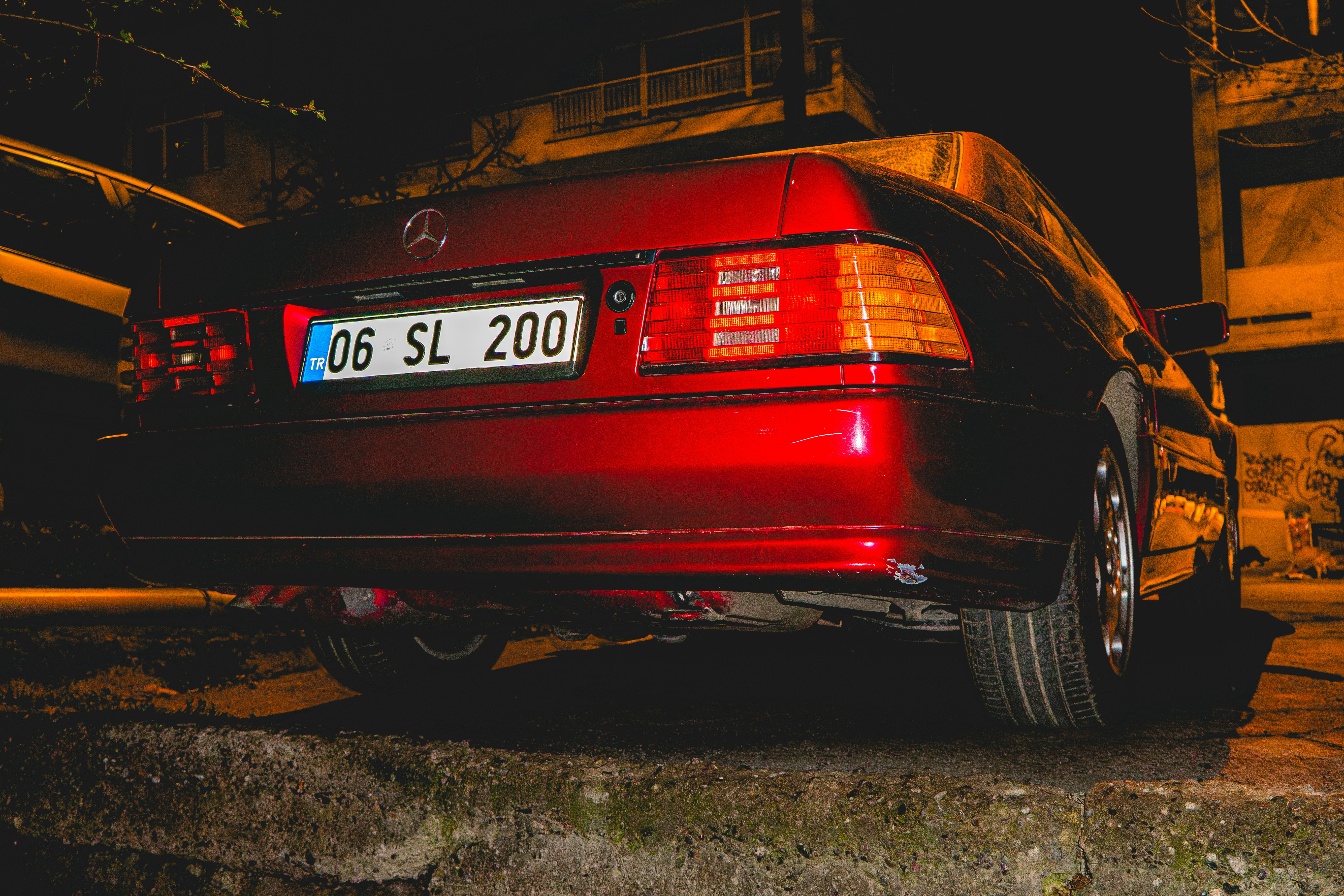 Red Mercedes at Night: Underside Detail in Urban Glow