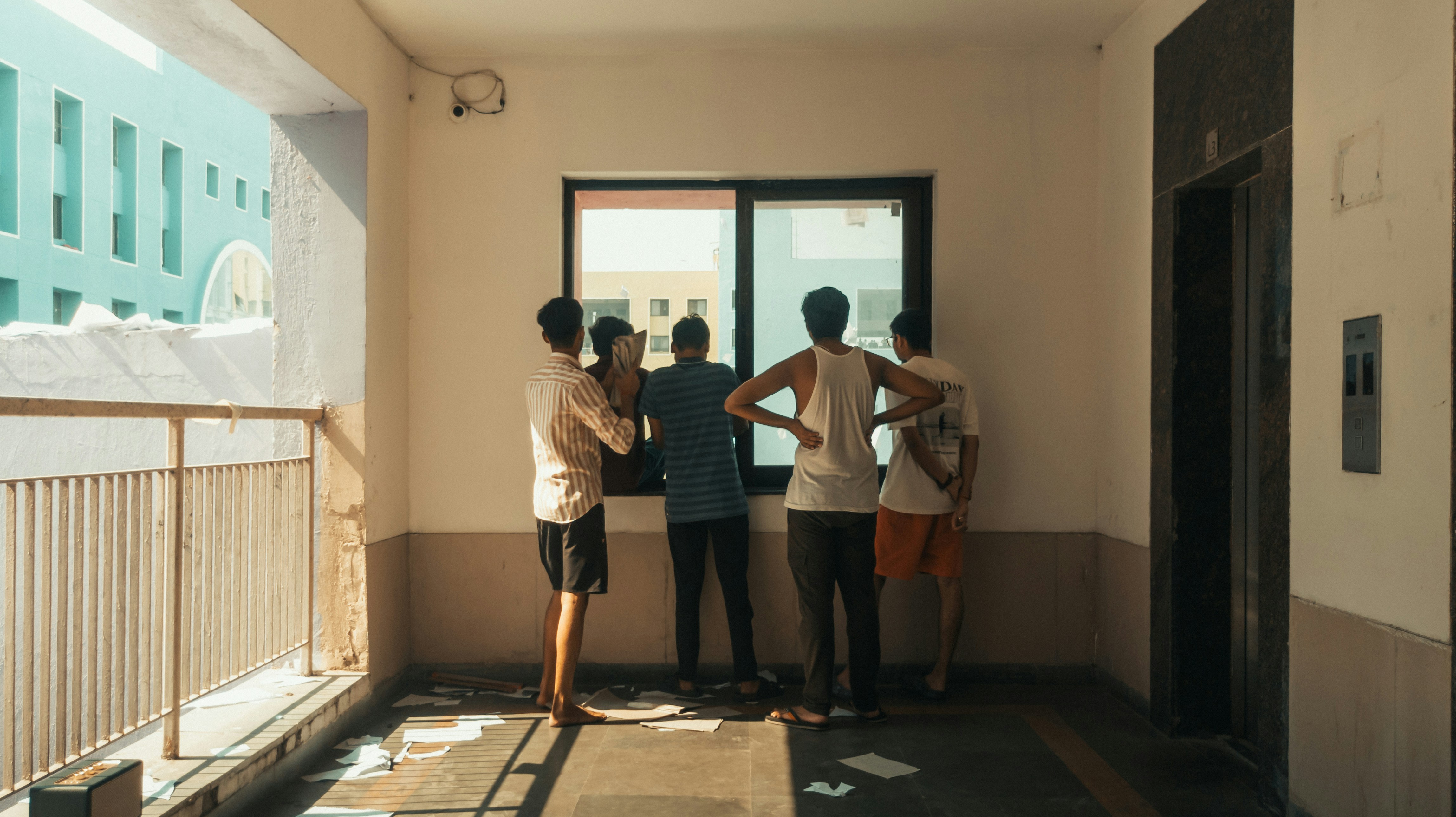 Huddle by the Window: A Group of Friends Inspect the World Beyond