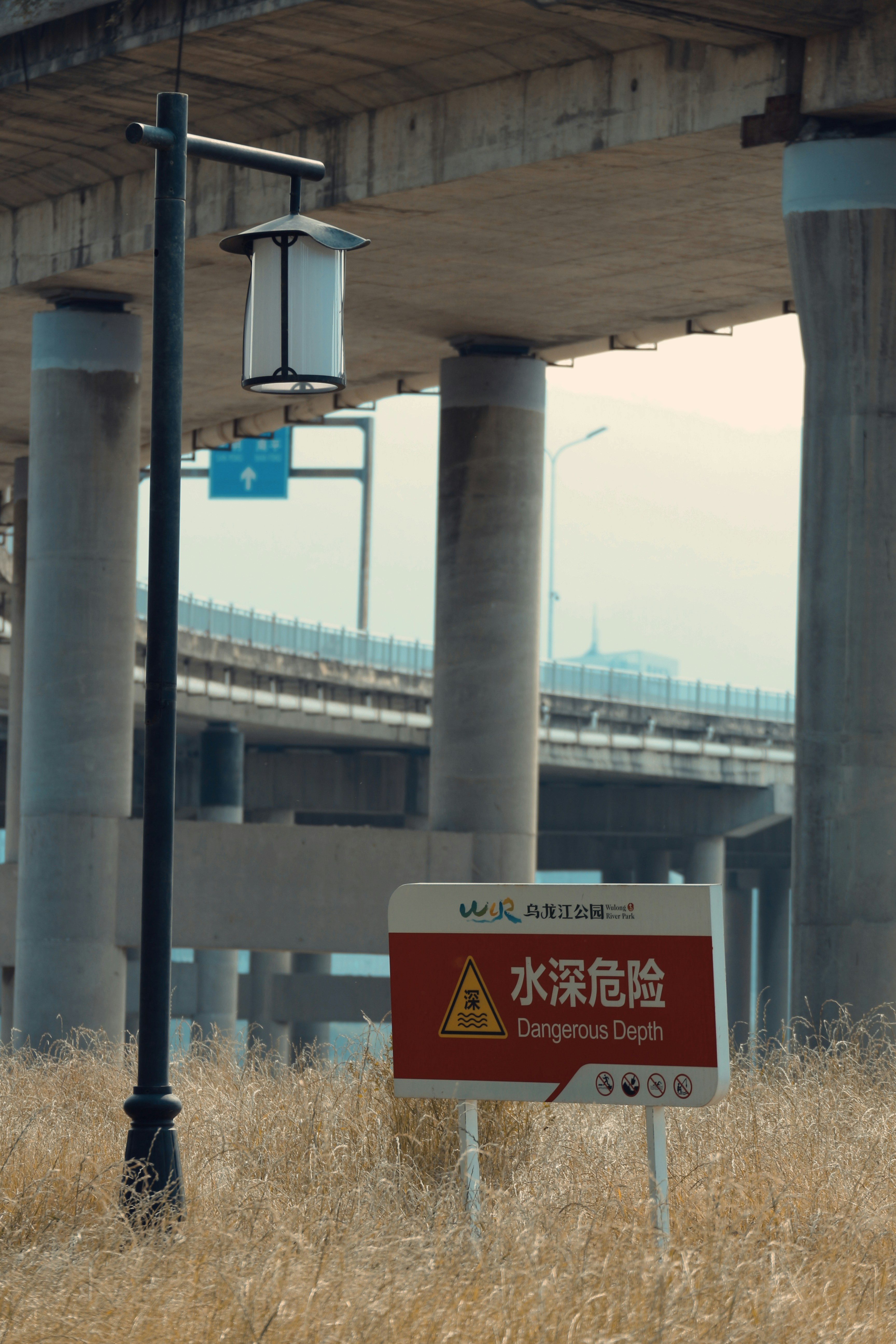 Suspended Warning: A Red Rectangle Beneath Concrete Giants