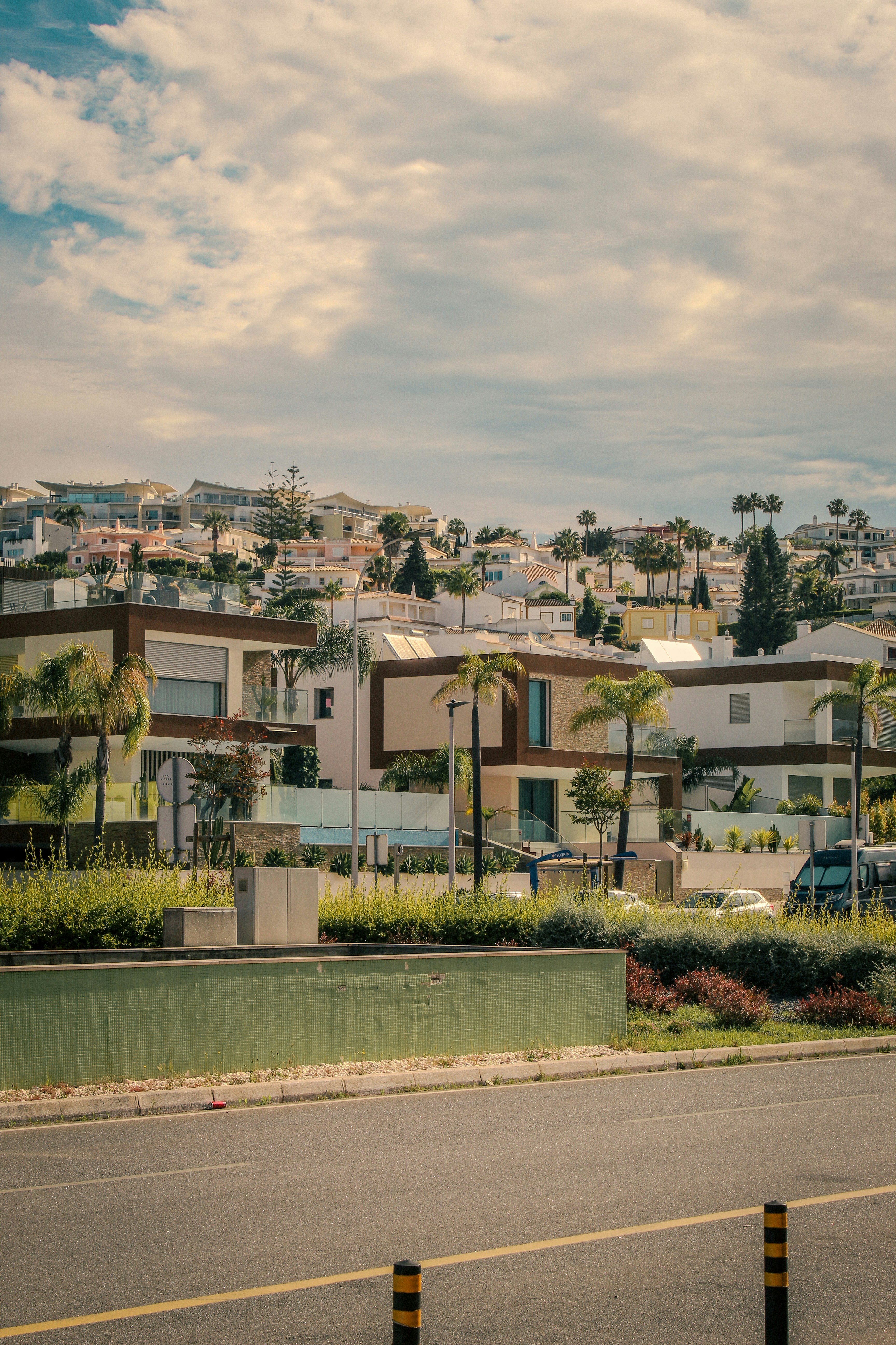Modern houses on a hillside under a cloudy sky
