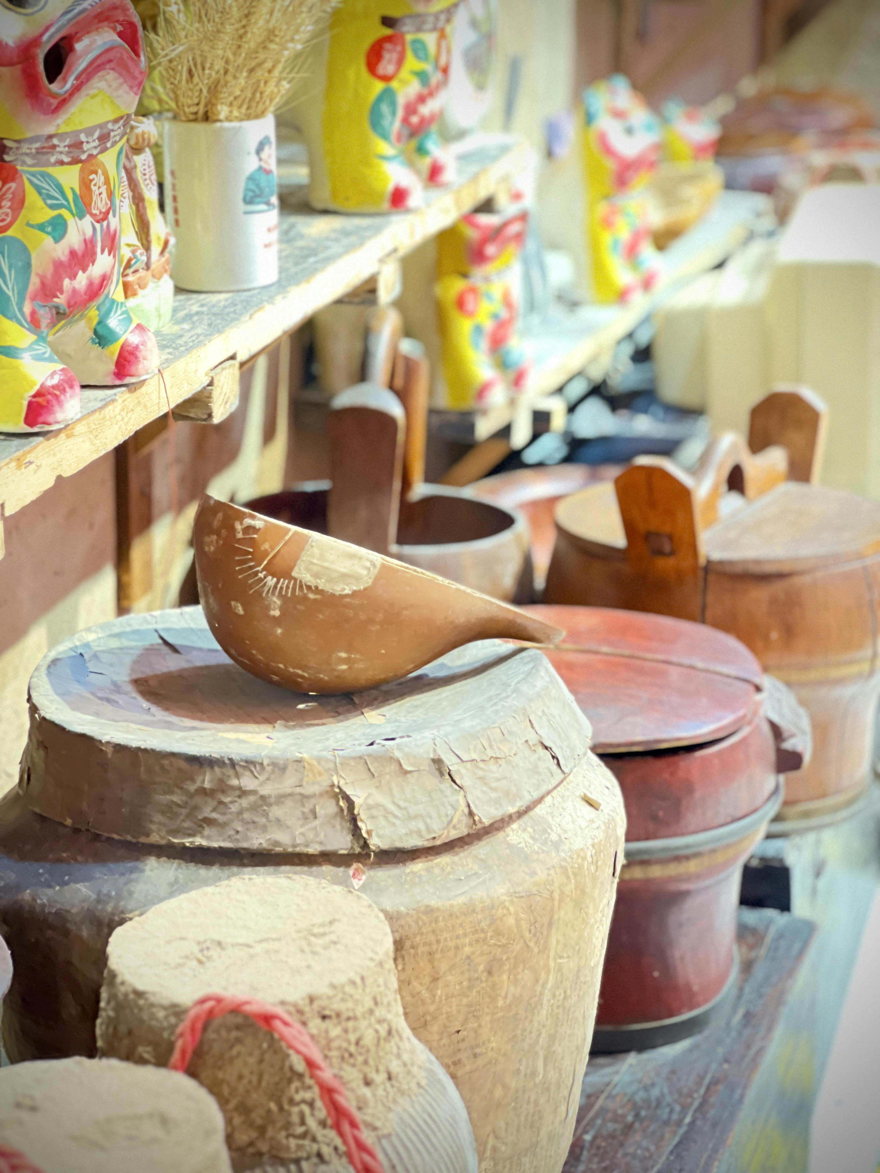 A rustic still life: clay pots with a wooden horn centerpiece