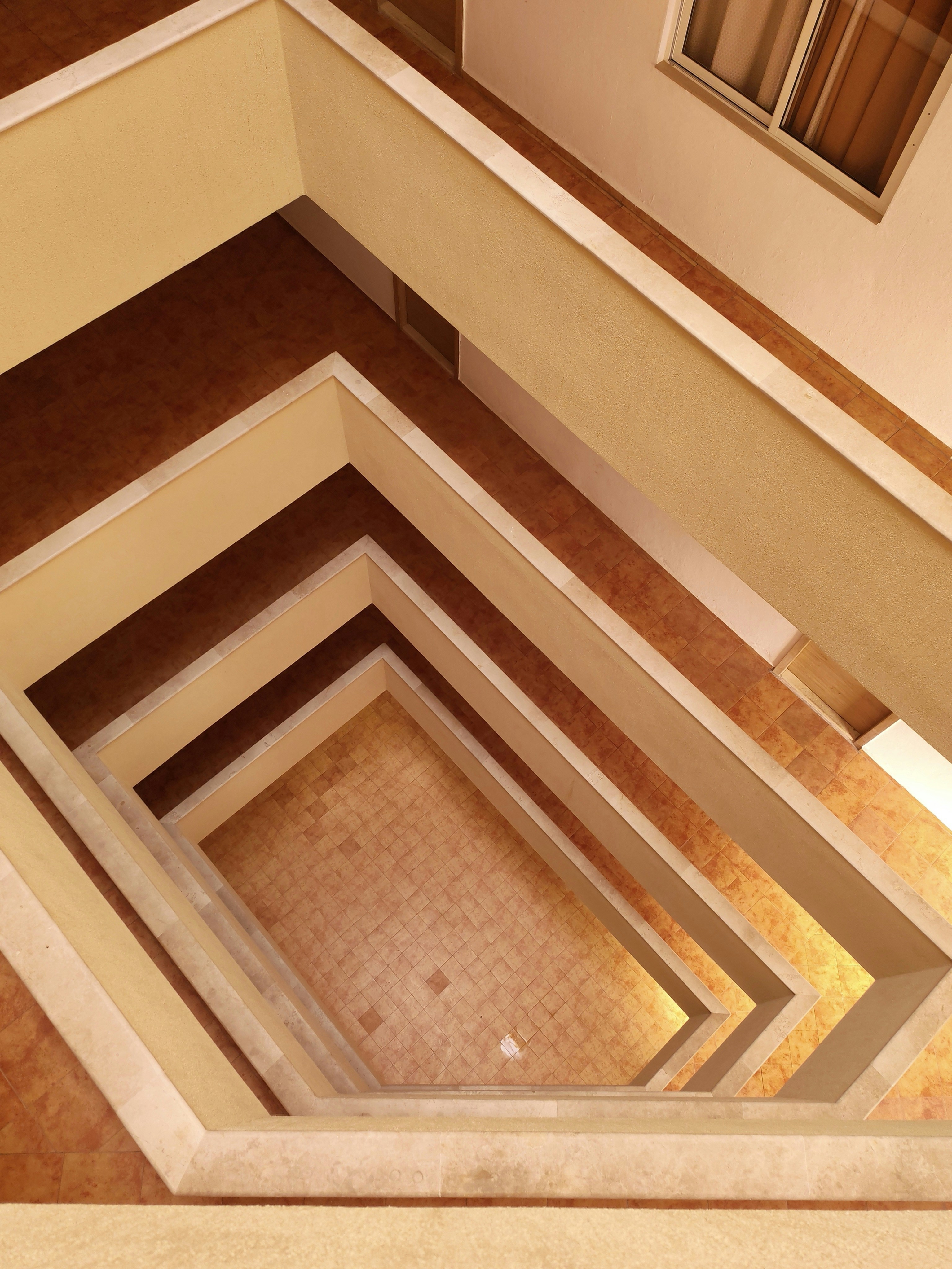 Architectural Spiral: A Rooftop Atrium Descends in Golden Light