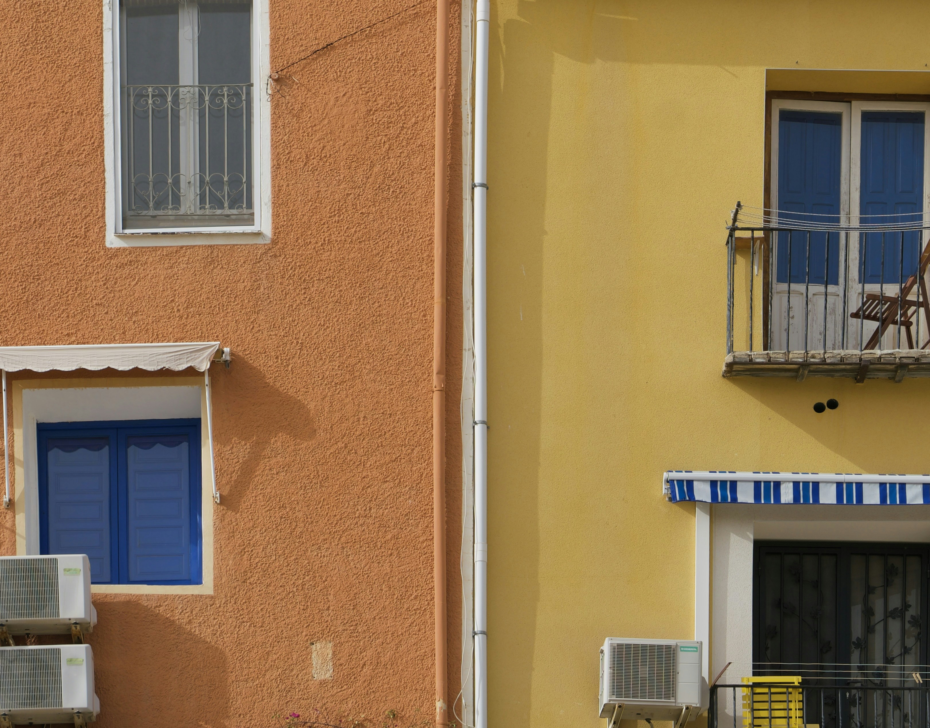 Two-Toned Facades: A Colorful Street of Orange and Yellow