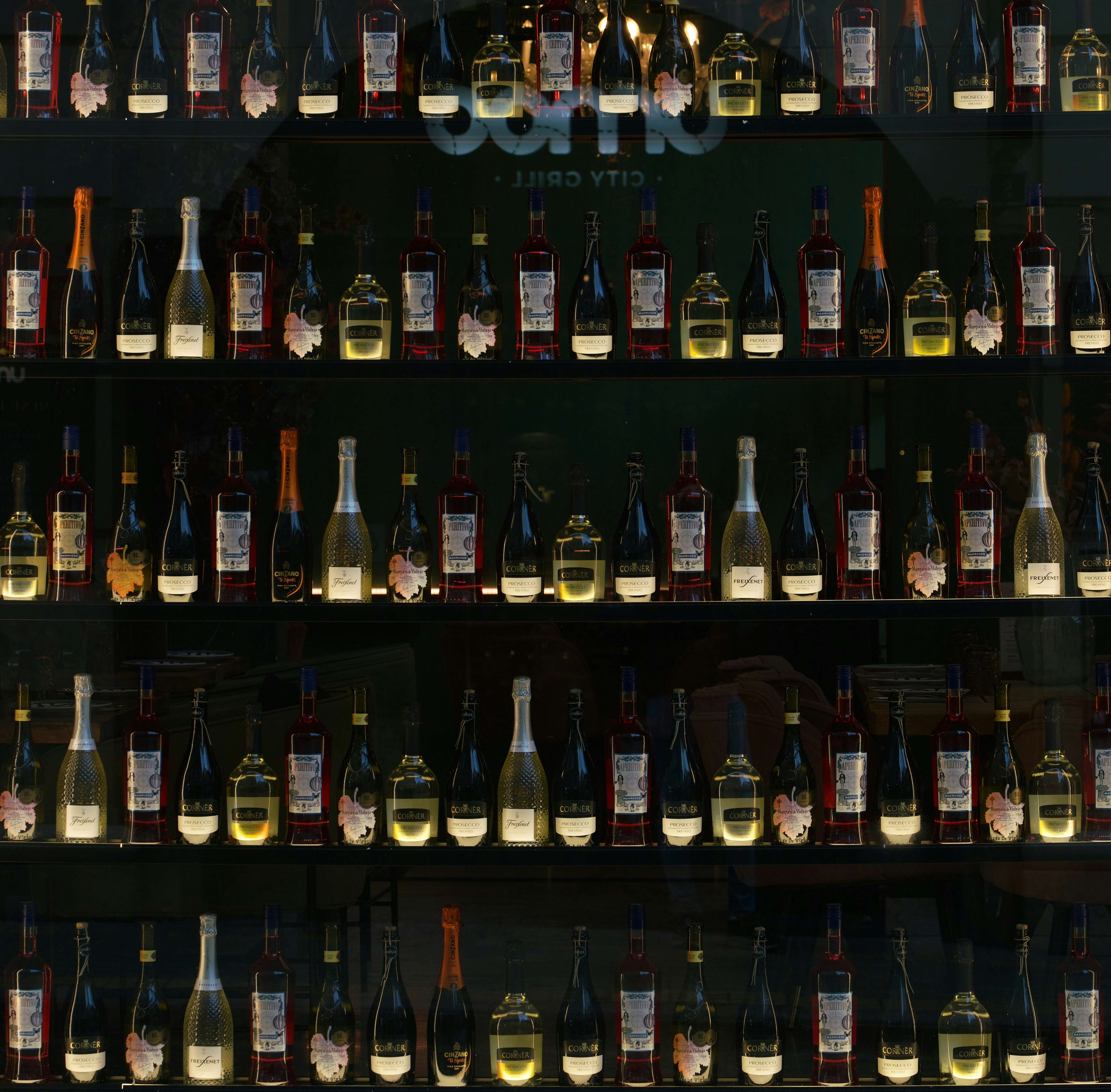 Liquid amber horizon: a shelf of bottles under dim bar light